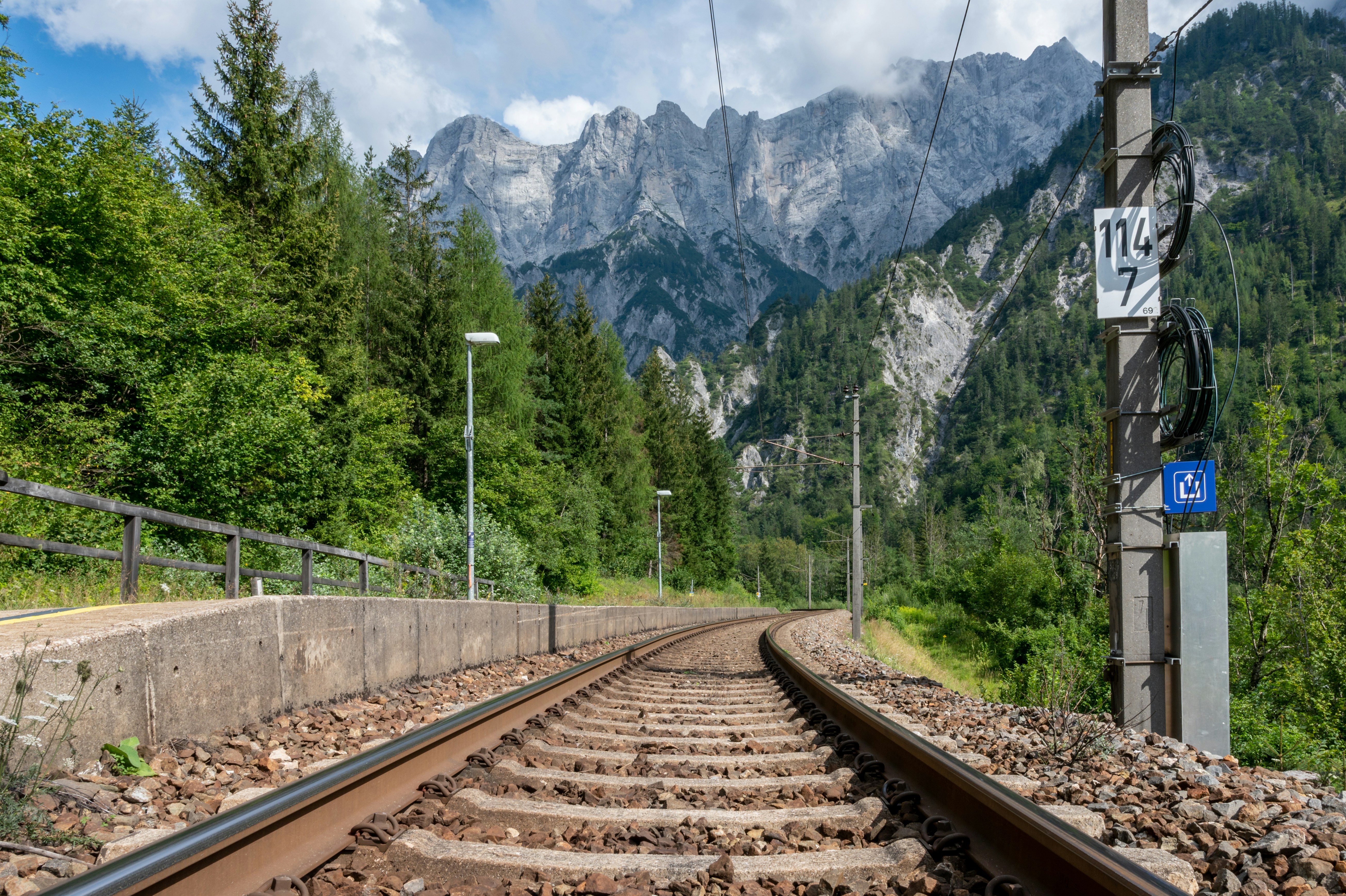Train tracks with trees and mountains in the background photo – Free ...