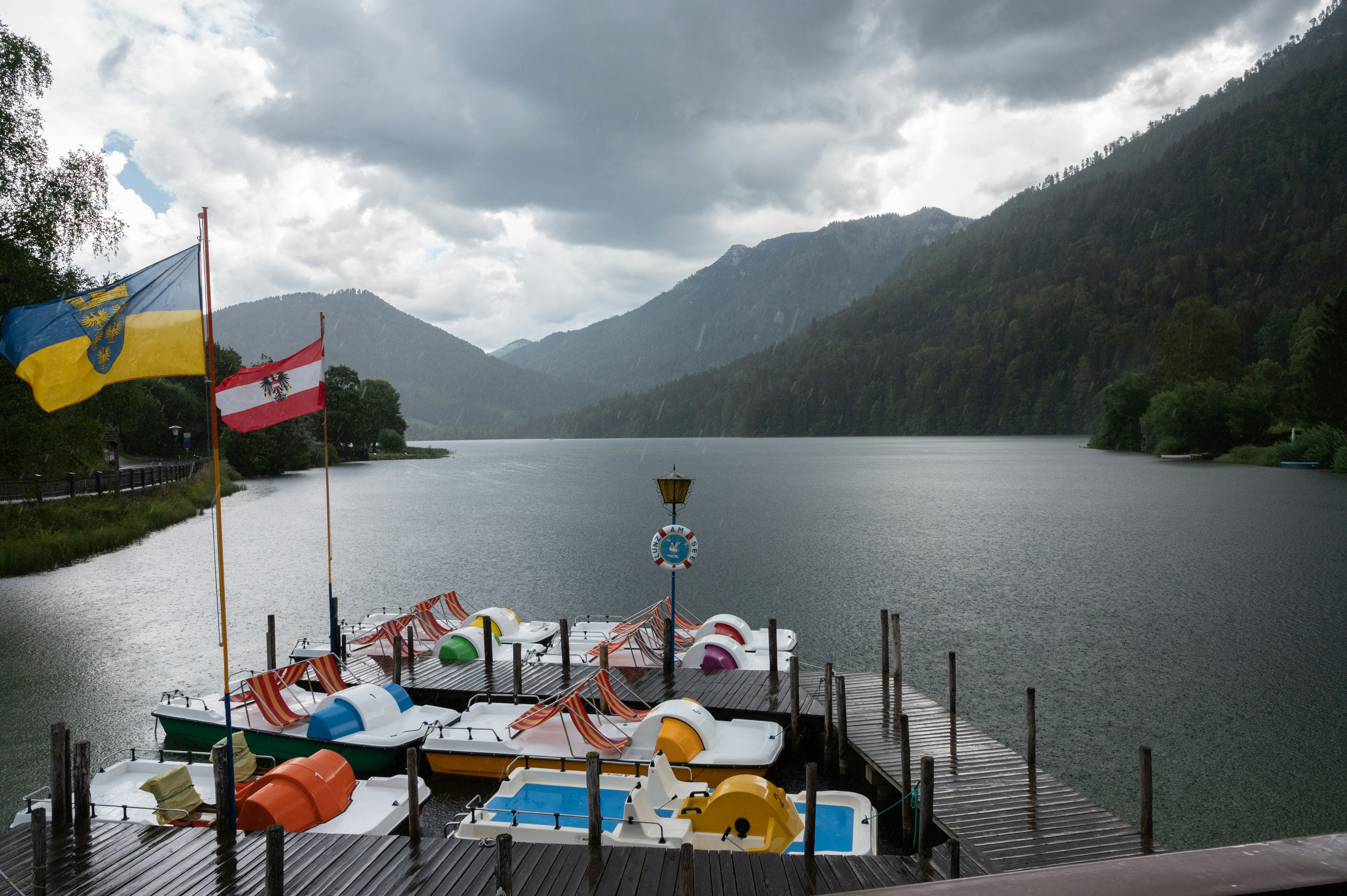 Colorful Pedal Boats Await at a Misty Alpine Lake Dock