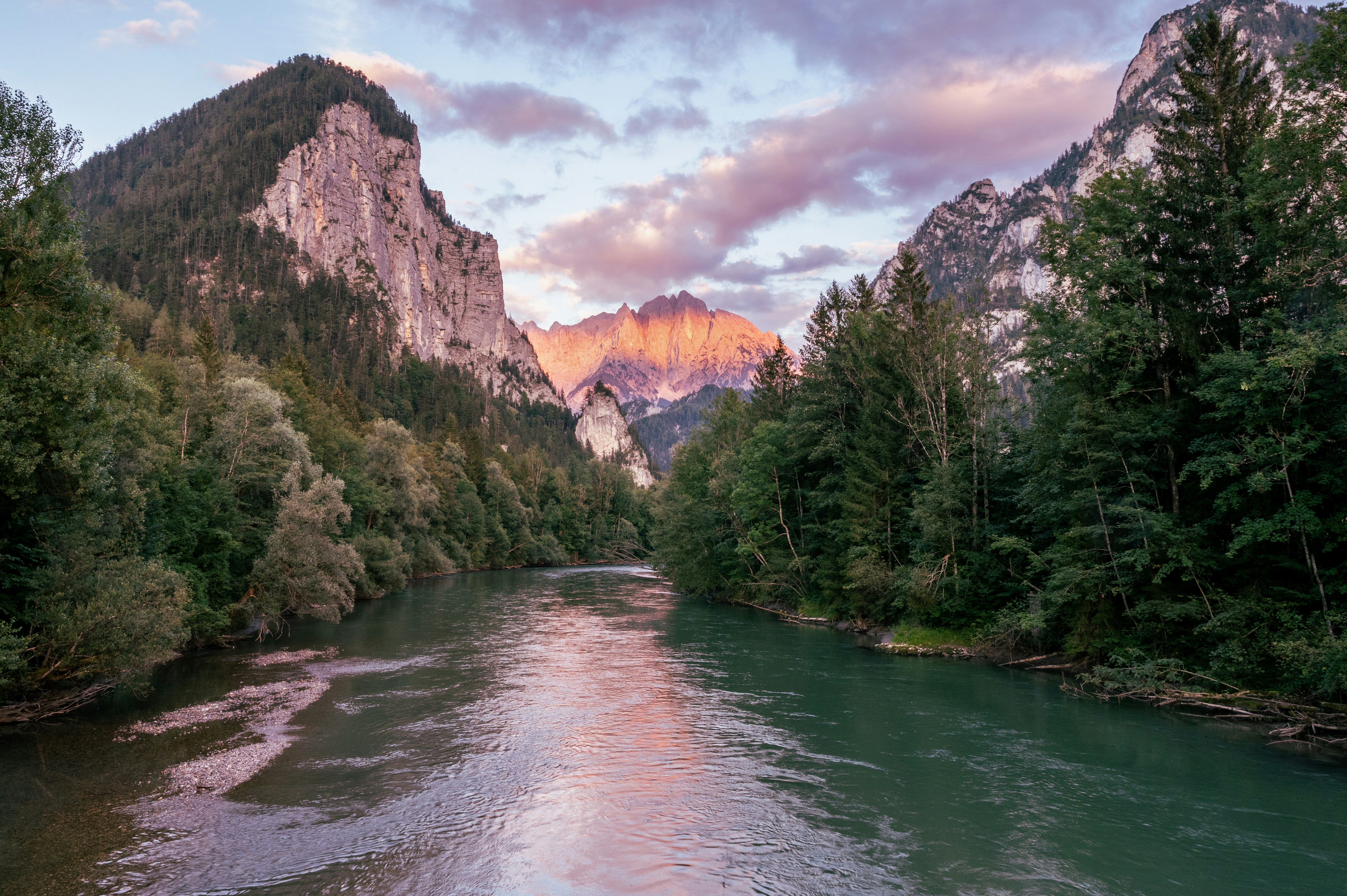 A river with trees and mountains in the background photo – Free Sunset ...