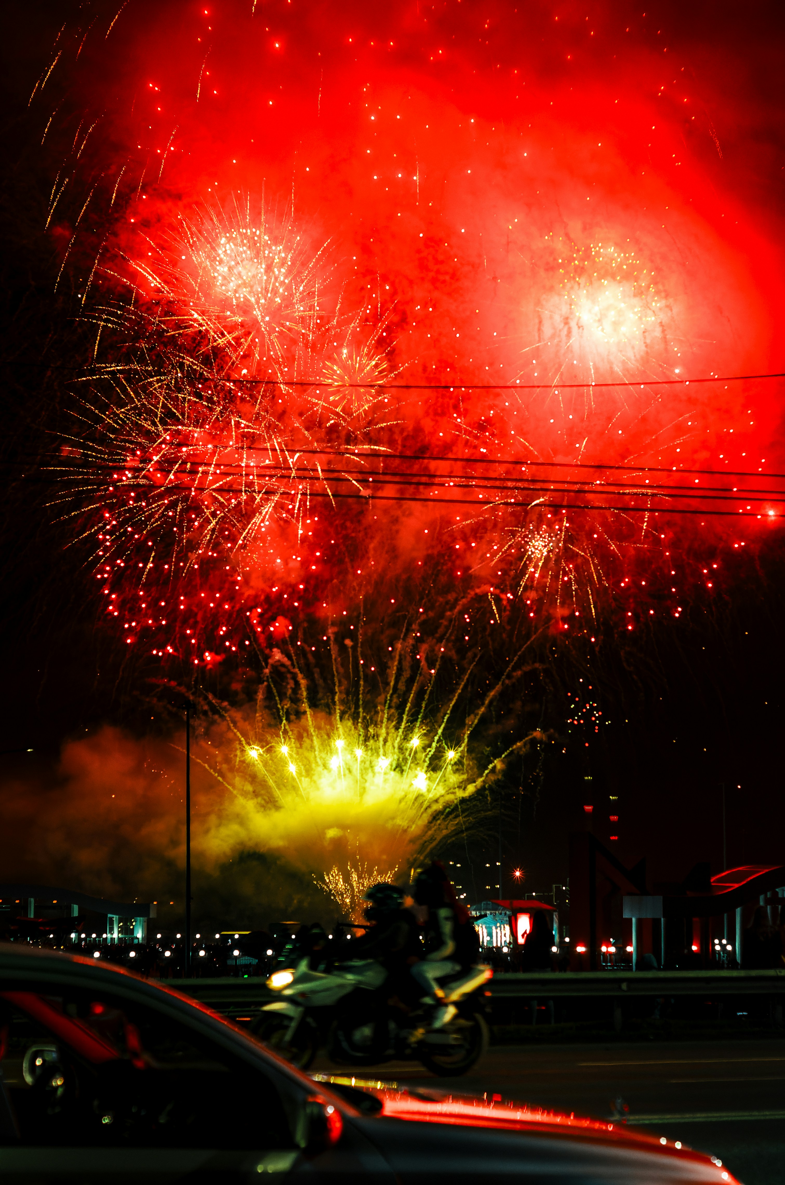 Scarlet Firework Cascade Over a Midnight Street