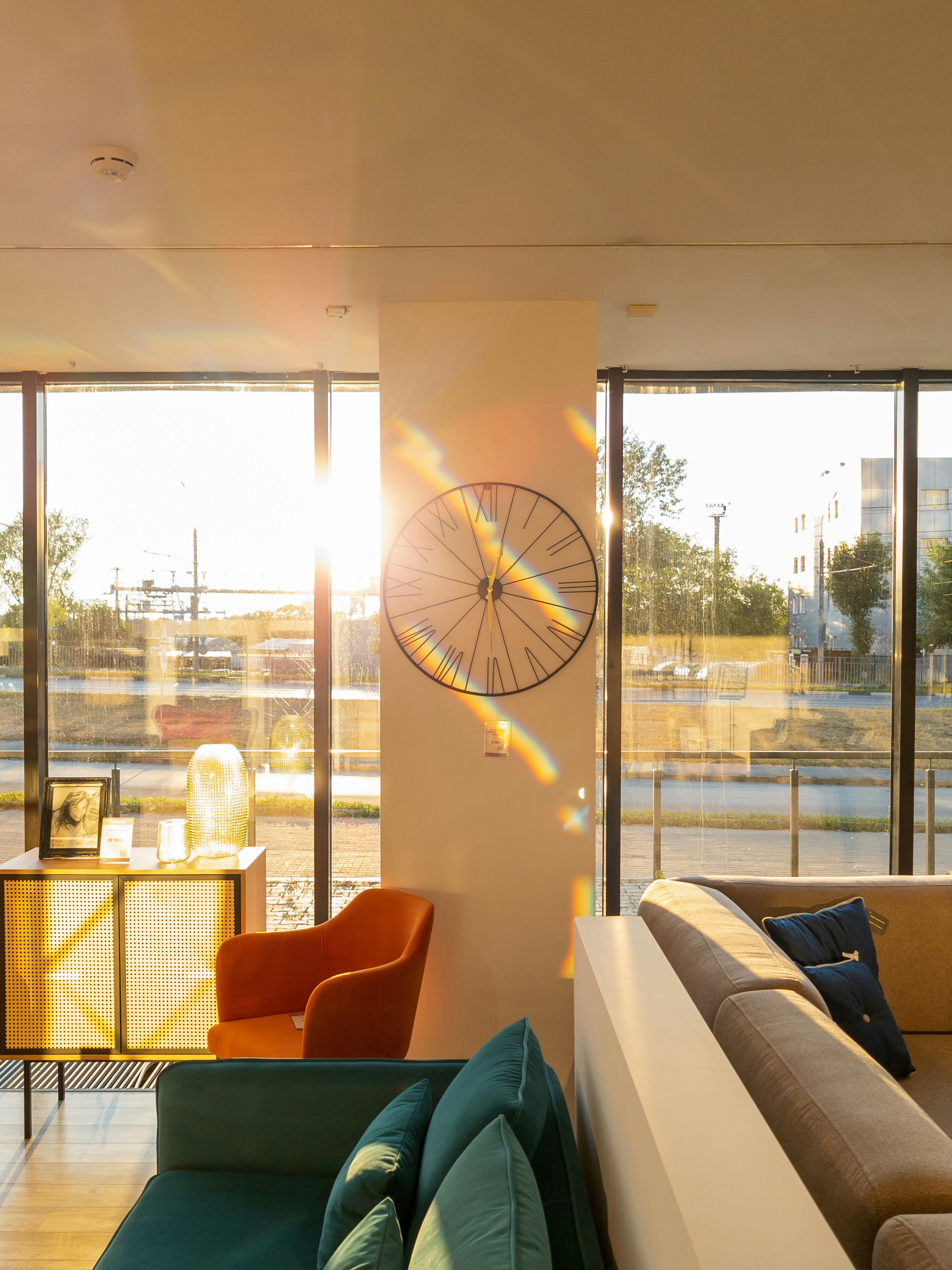 Prism Rainbows and a Central Clock in a Sunlit Lobby