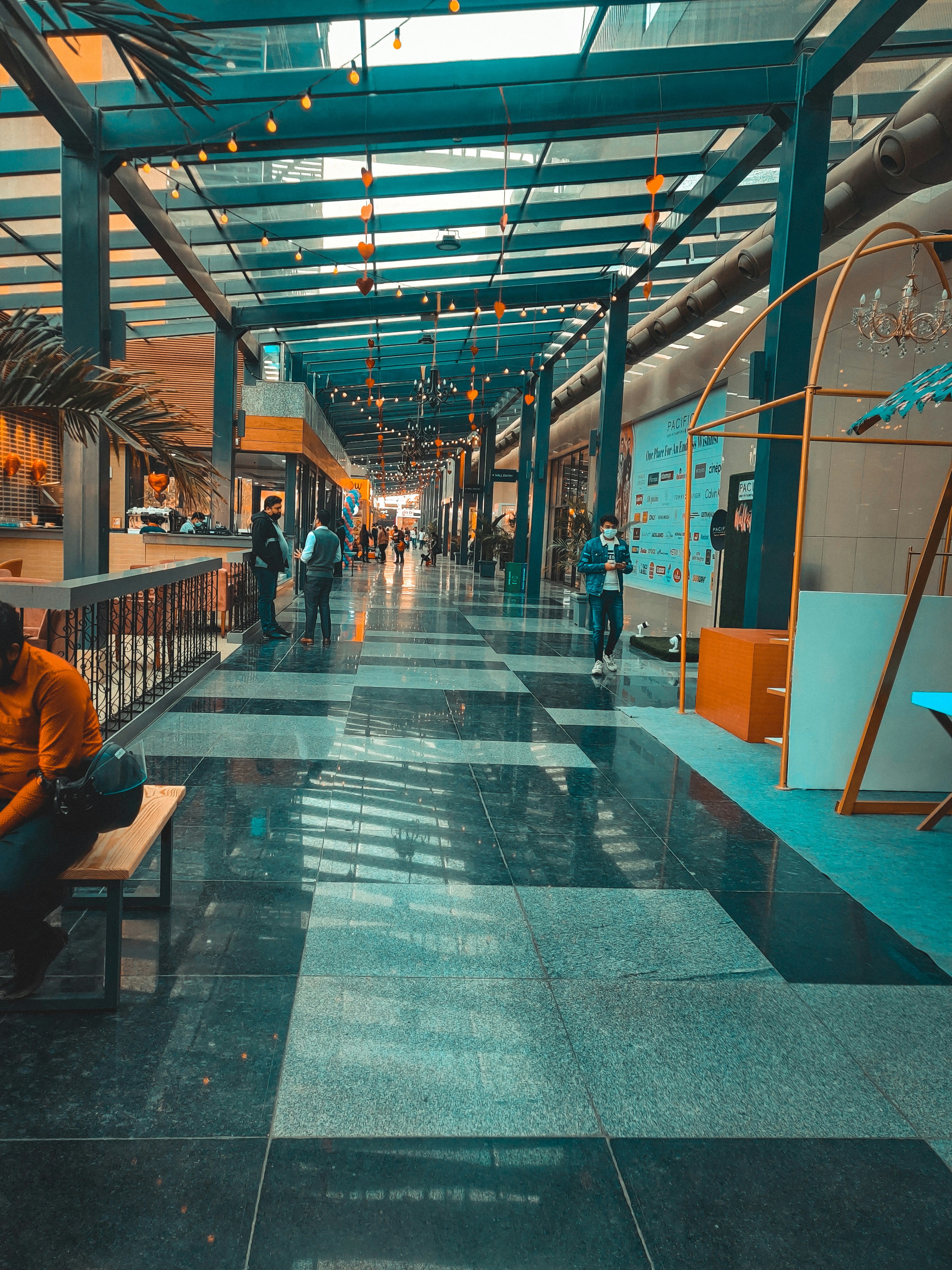 Crossing Lines: A Modern Atrium Walkway in Teal and Amber