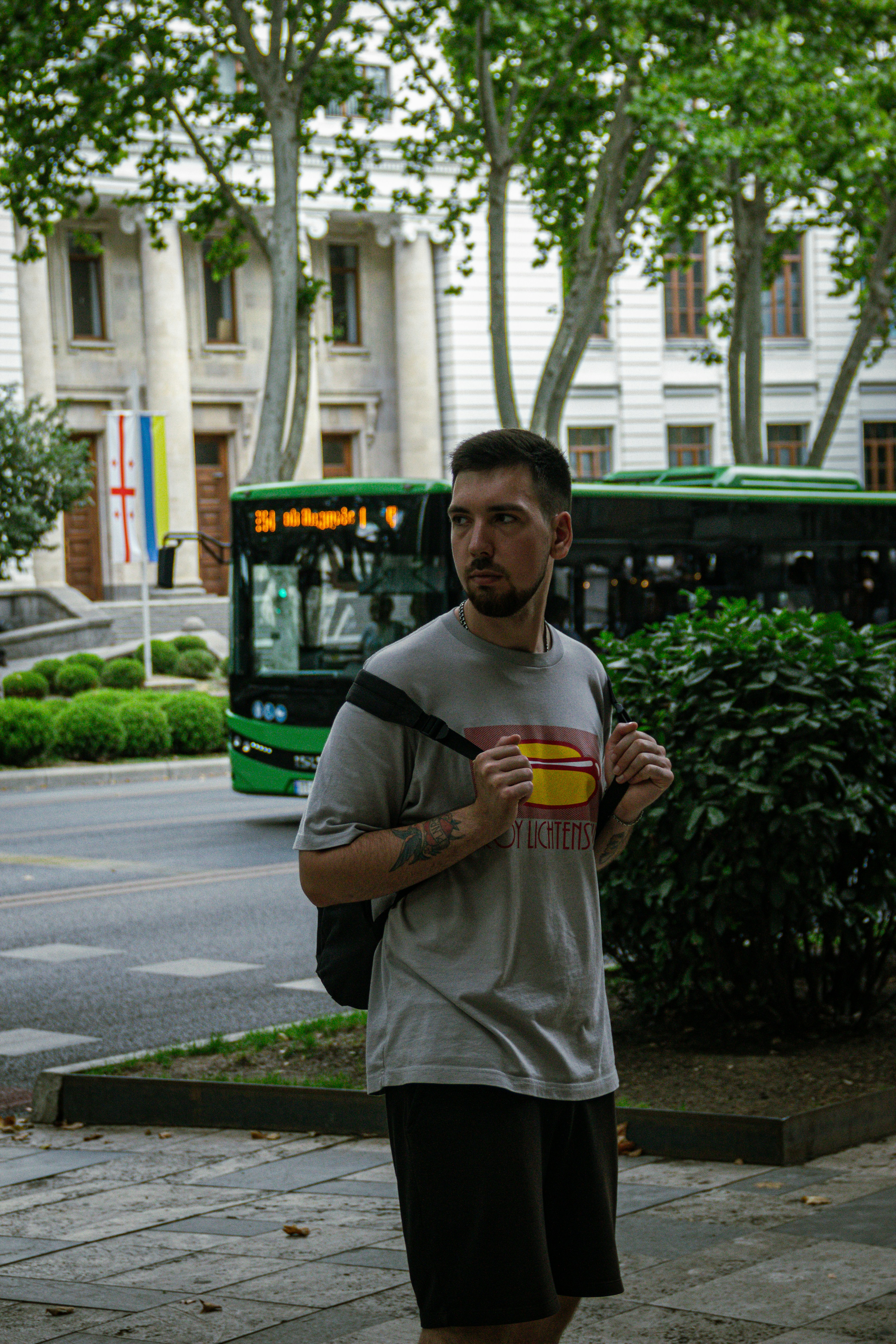 Adjusting the Moment: A Street Portrait Under Neon Green Canopy