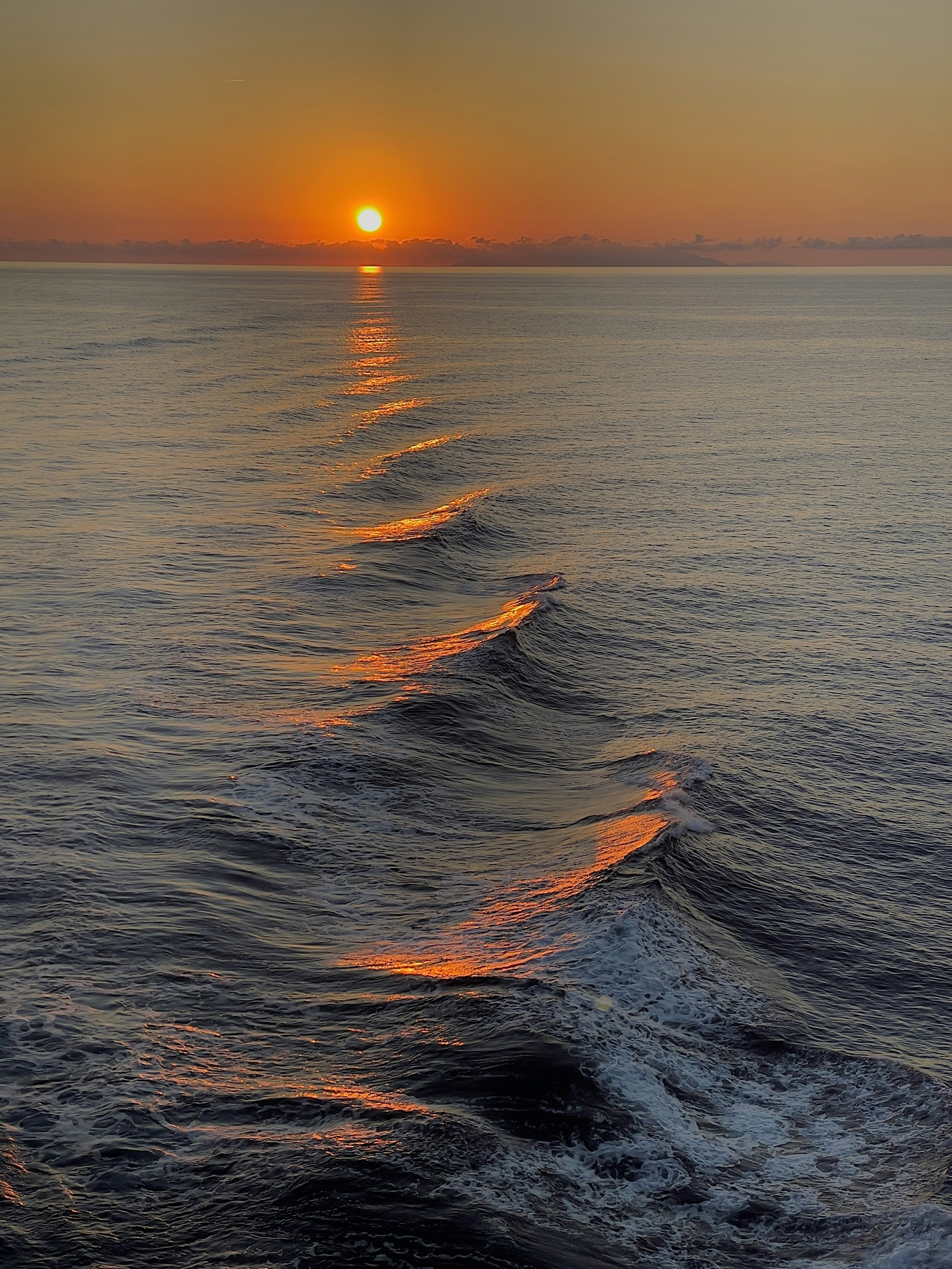 Sunlit Ribbon: Sunset Waves Mark the Horizon