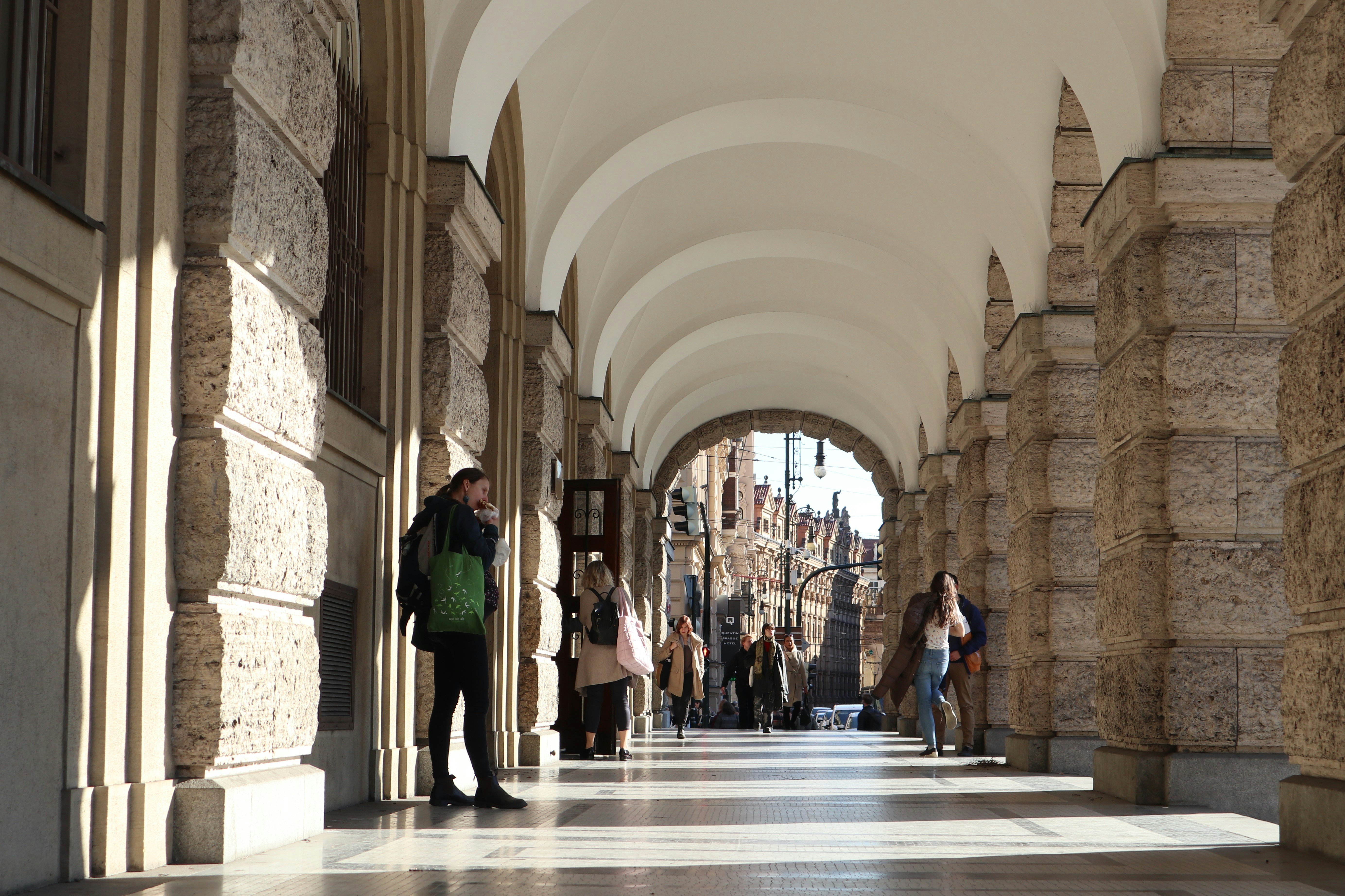A group of people walking through a building photo – Free Wallpaper ...