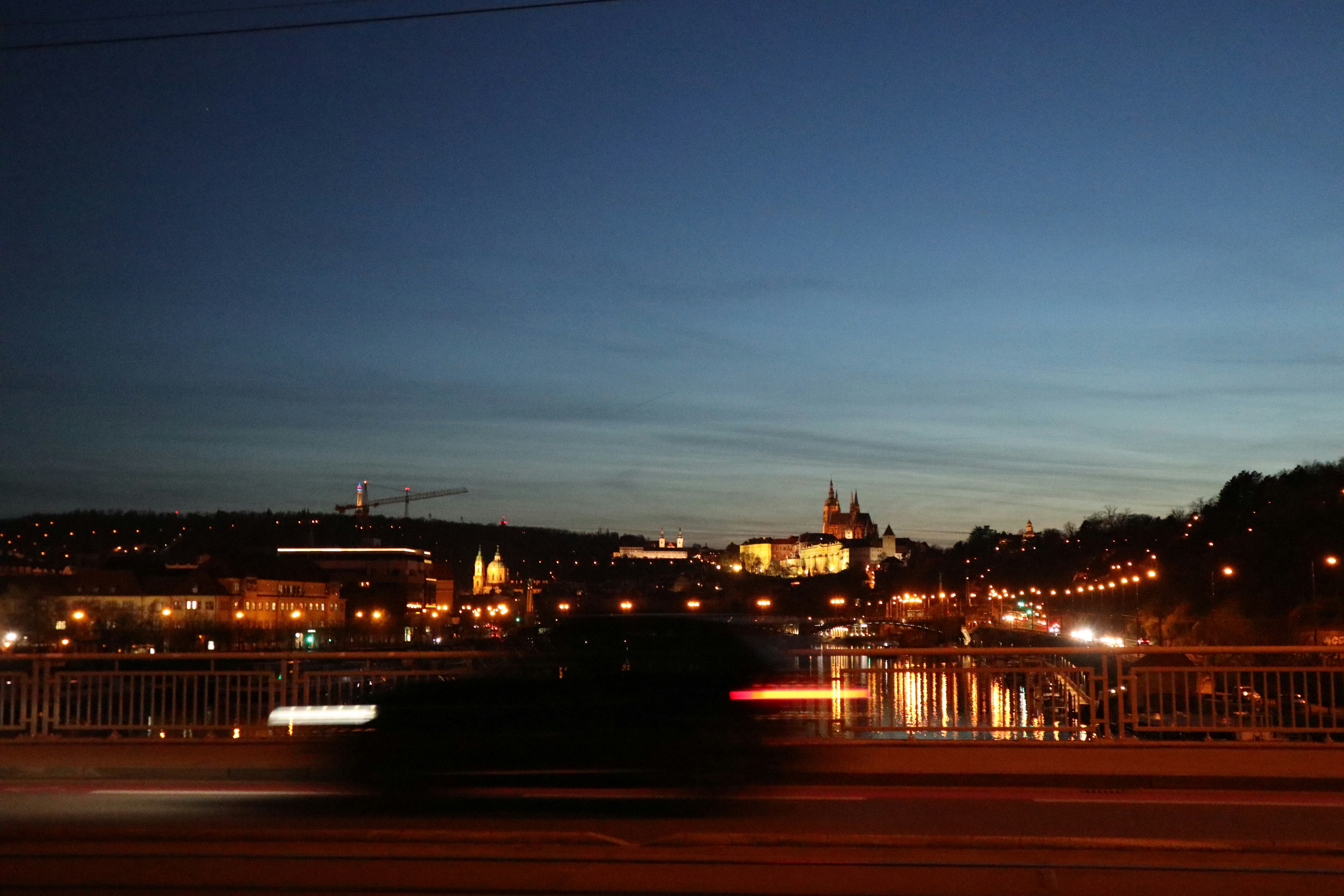 Midnight Skyline: Light Trails Over a Quiet River Bridge
