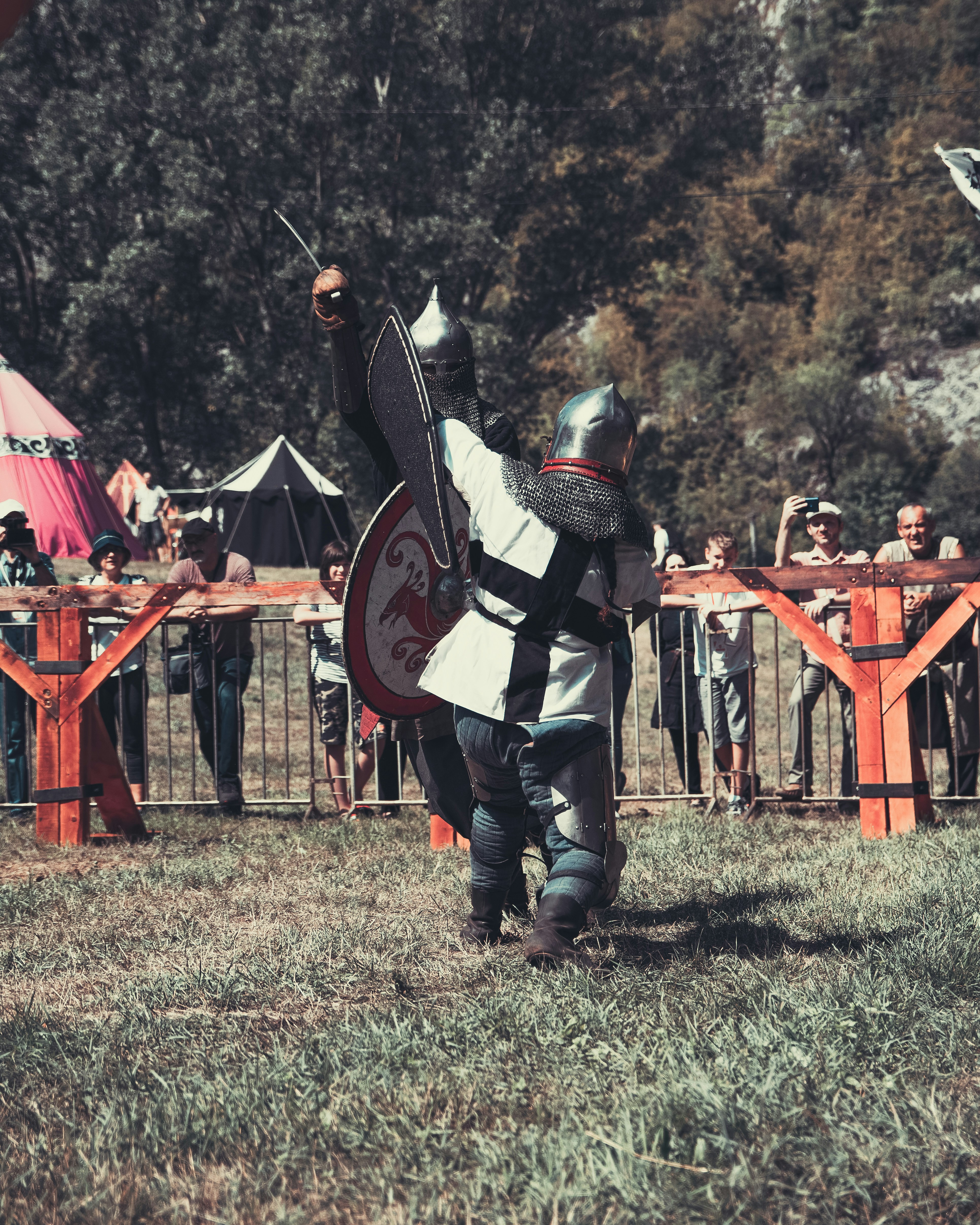 A person in a garment holding a shield and sword photo – Free Knight ...
