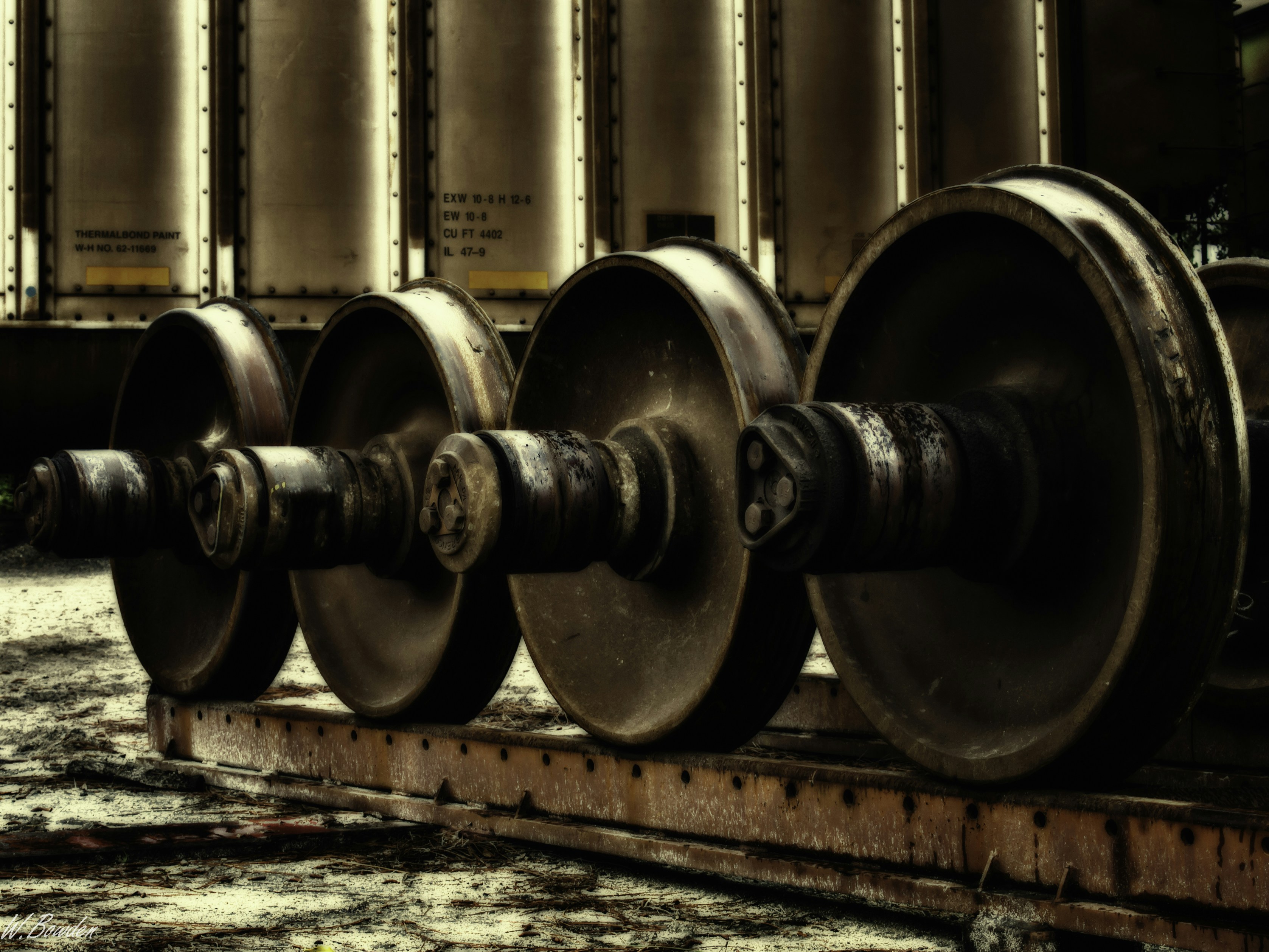 Dawn-Warmed Wheels: A Row of Rusted Giants on Track