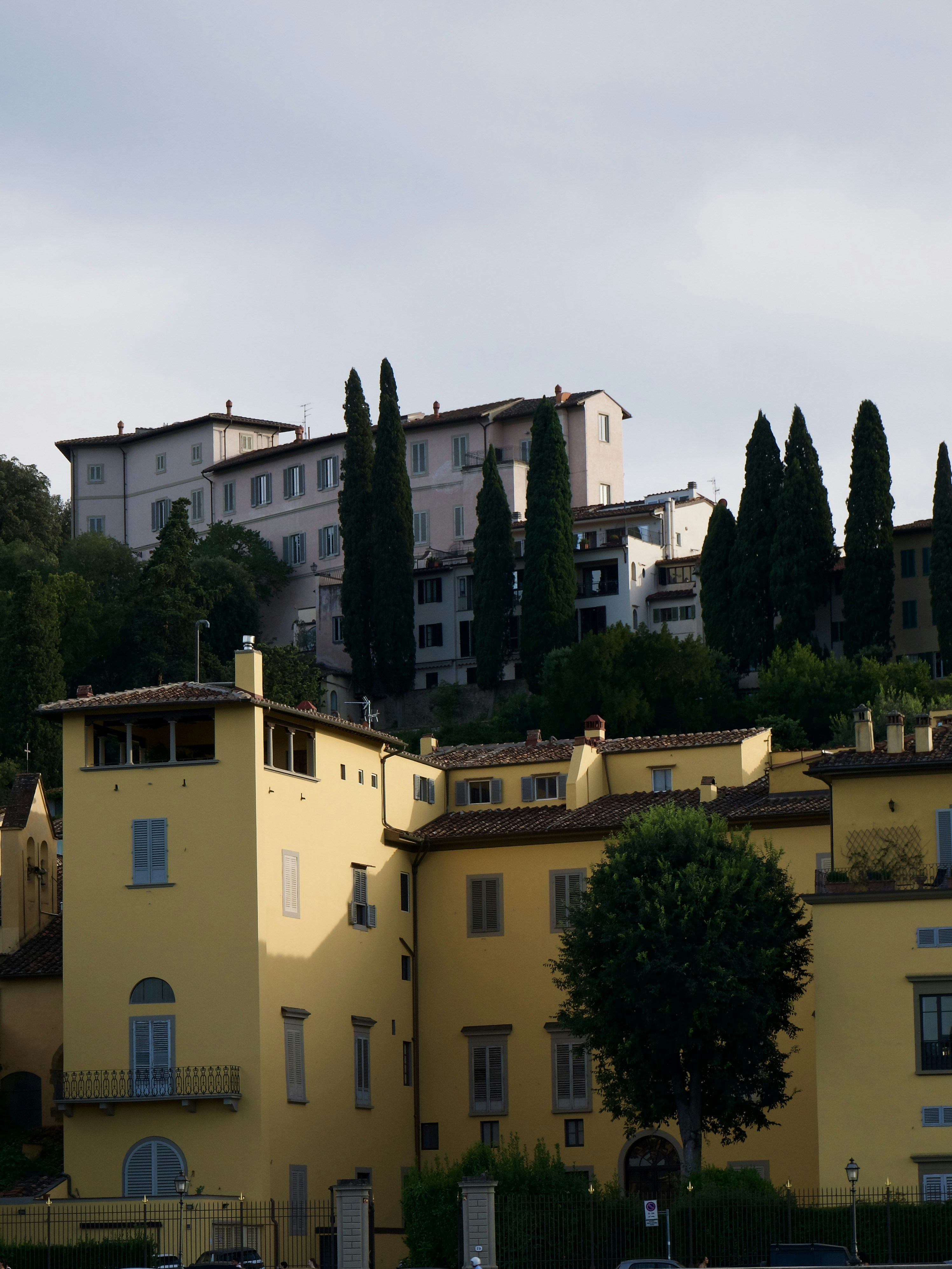 a group of buildings with trees in front of them