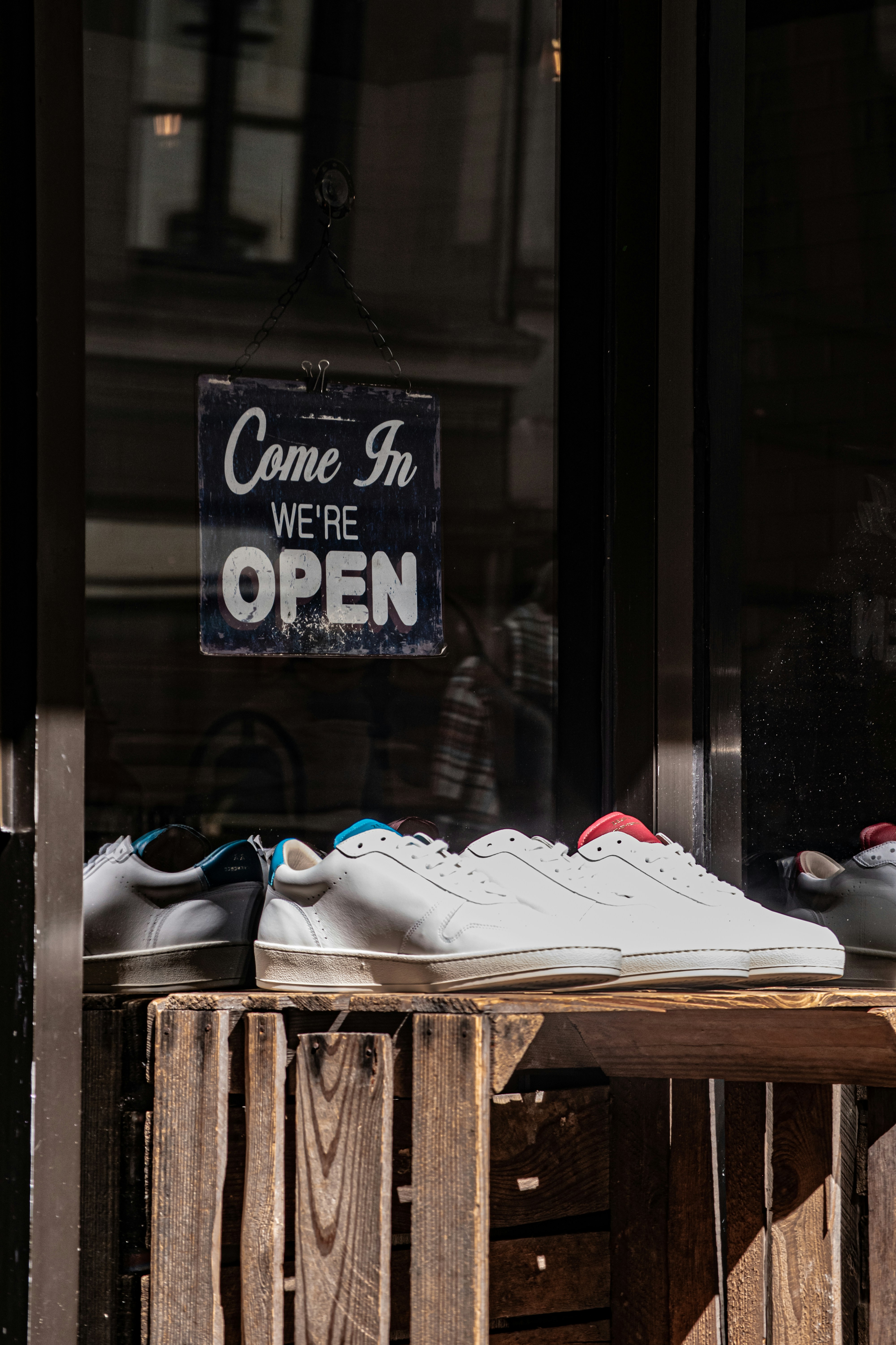 Open Sign Over White Sneakers: A Quiet Window Display