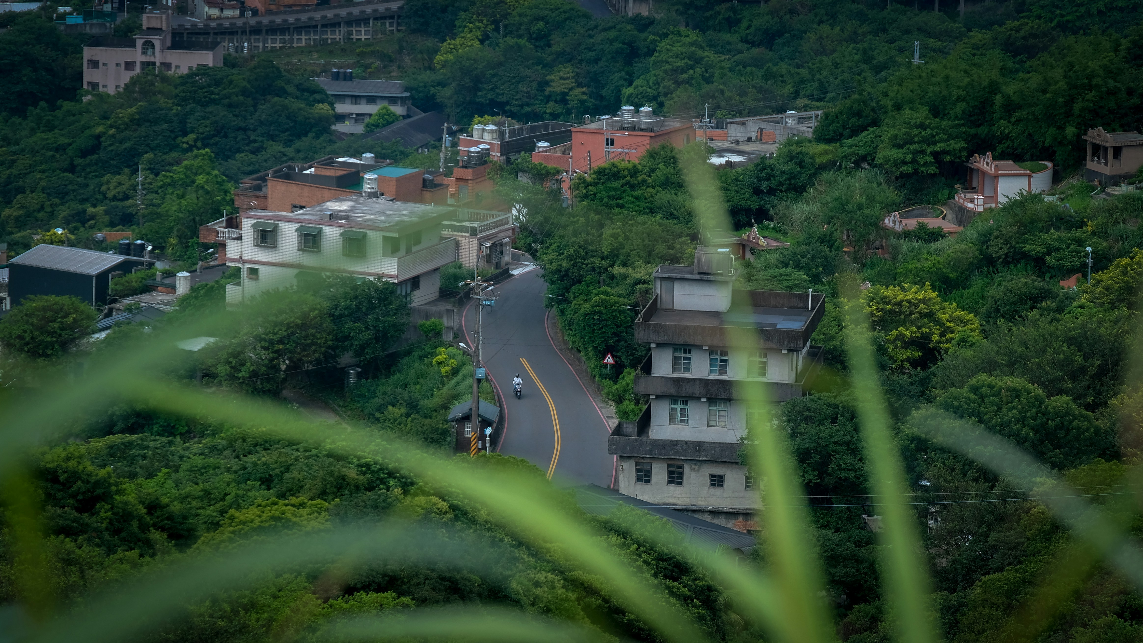 Serpentine Road Through a Green Hillside Village