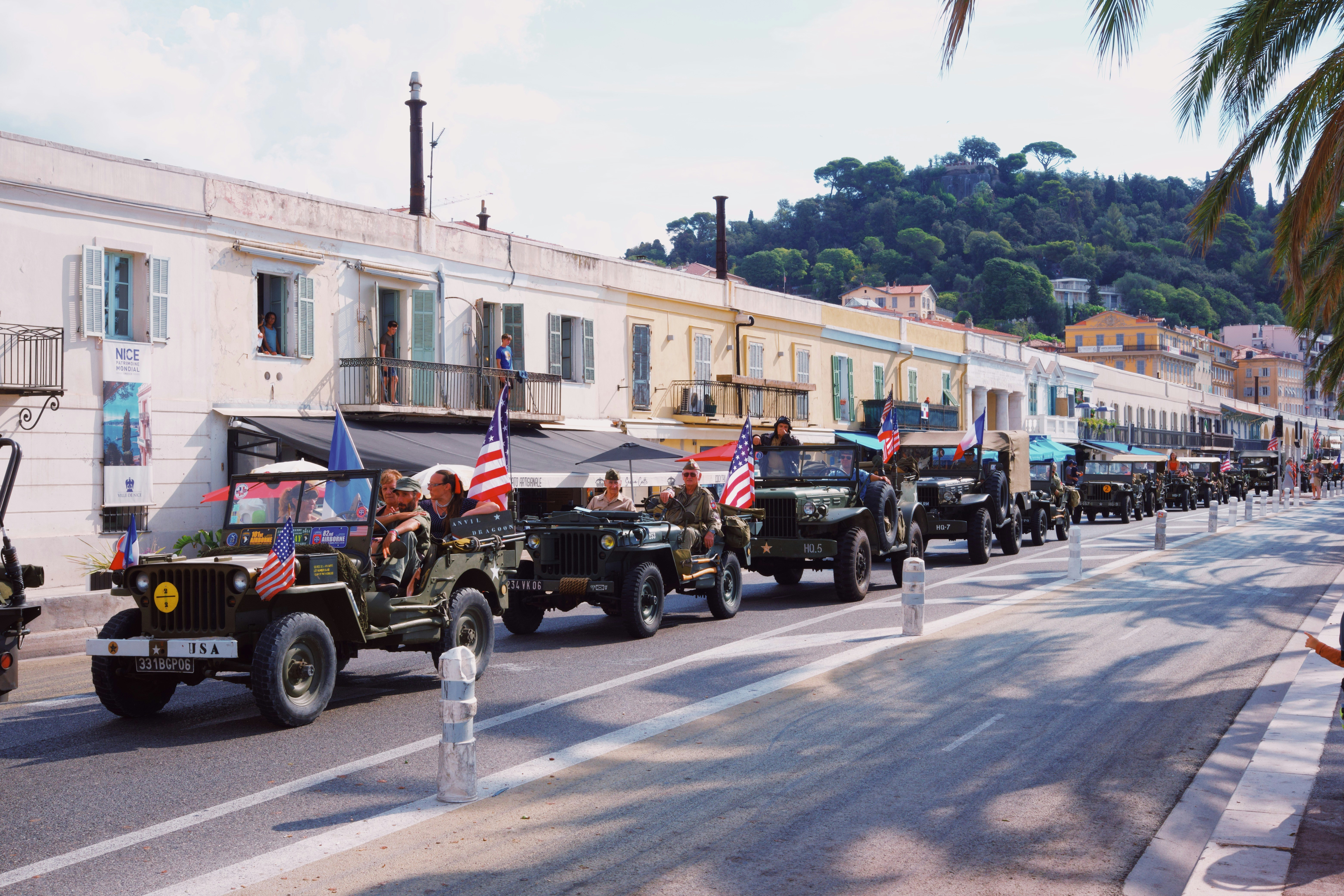 Pastel Parade: Vintage Jeeps Roll Through a Sunlit Coastal Street