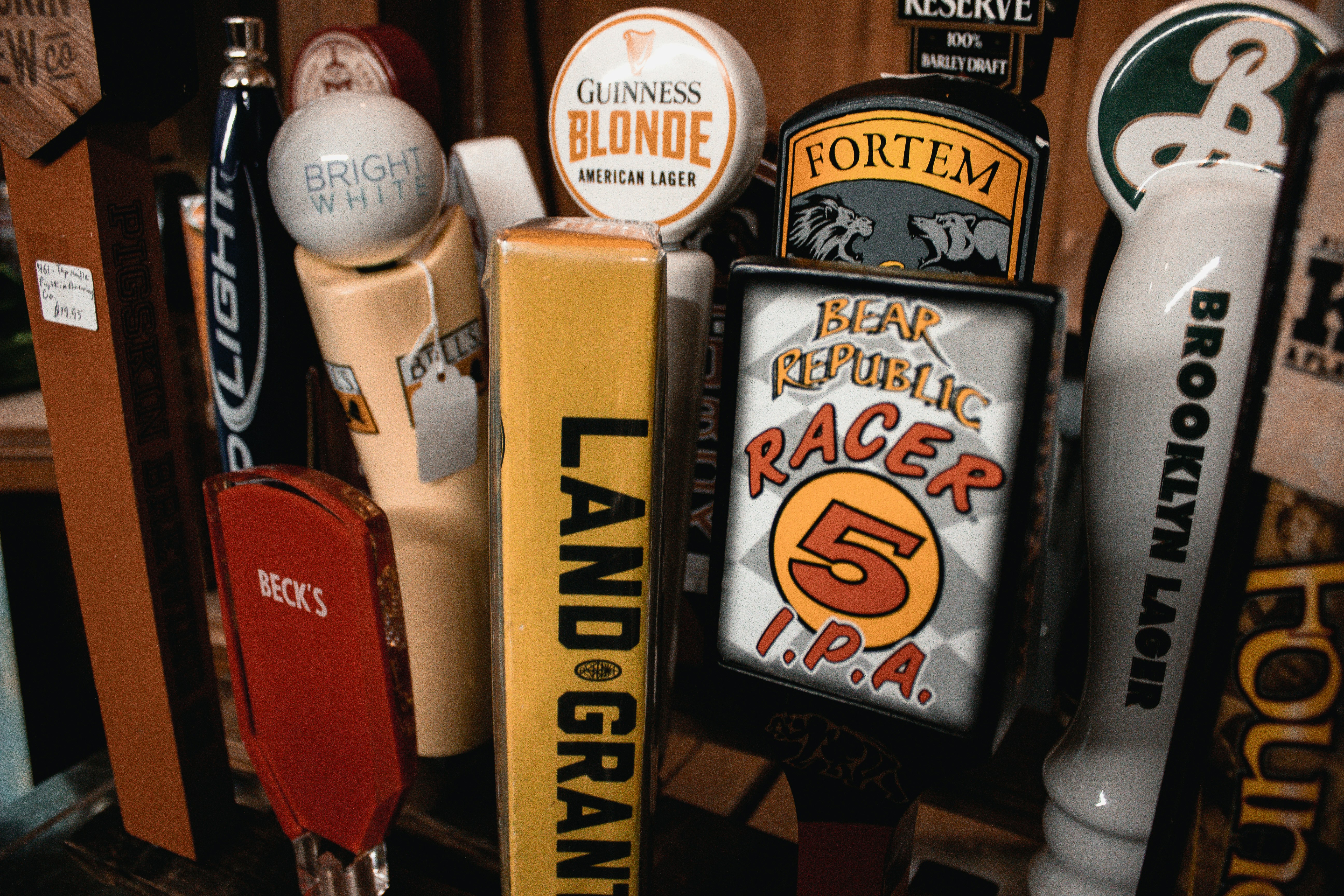At the Bar Exchange: A Row of Tap Handles Stacked with Brand Names