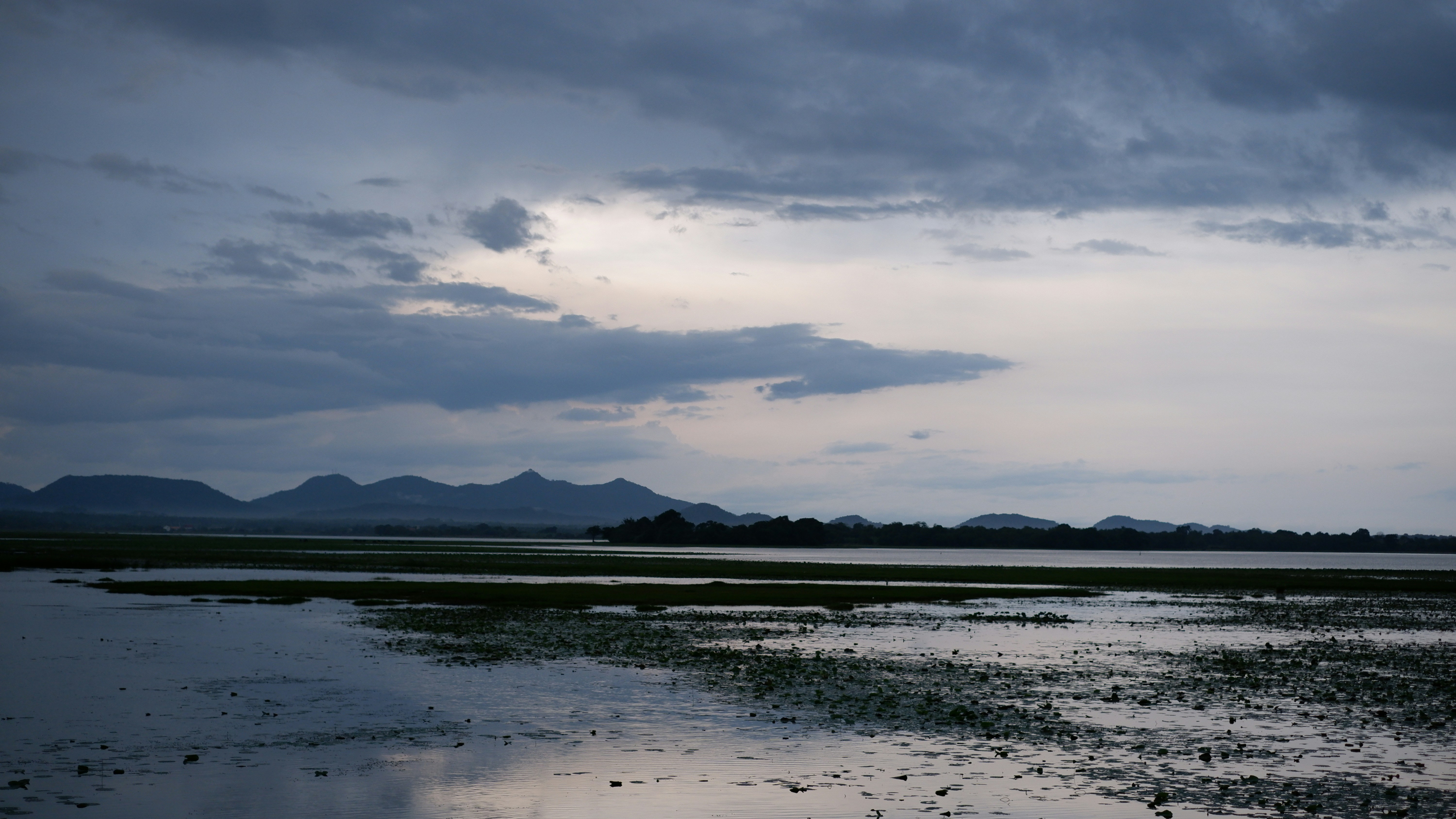 A large flat area with a body of water in it photo – Free Grey Image on ...