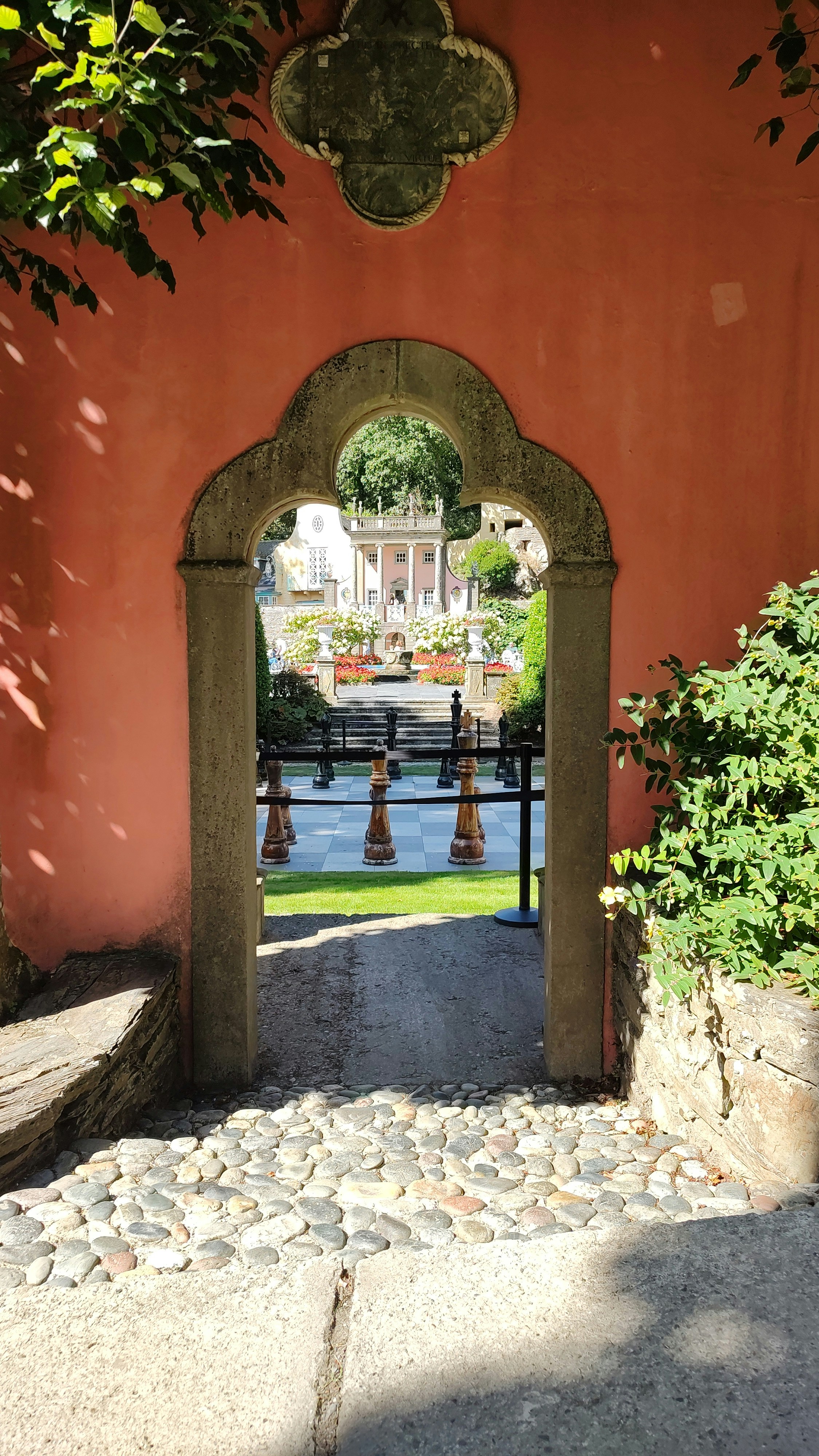 A stone archway with a walkway and a stone walkway photo – Free ...