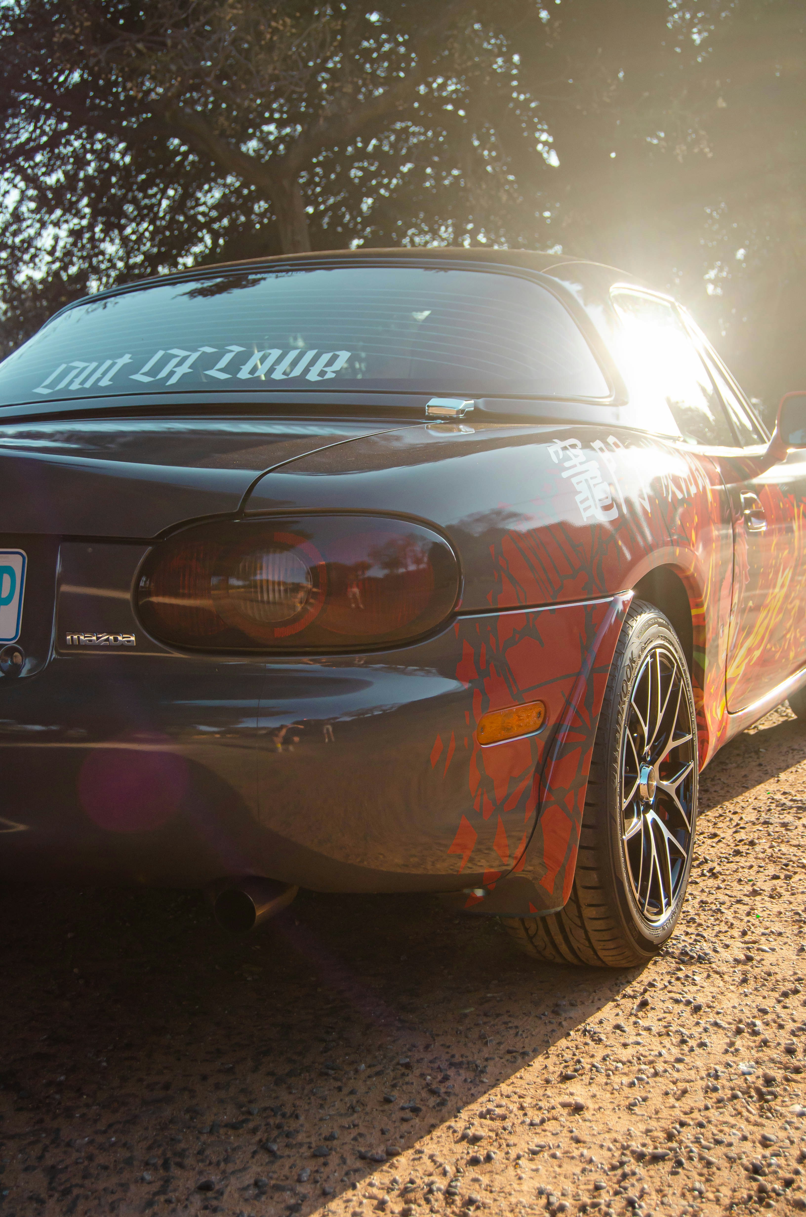 Sunlit Stance: A Modified Mazda Glints Under Golden Hour