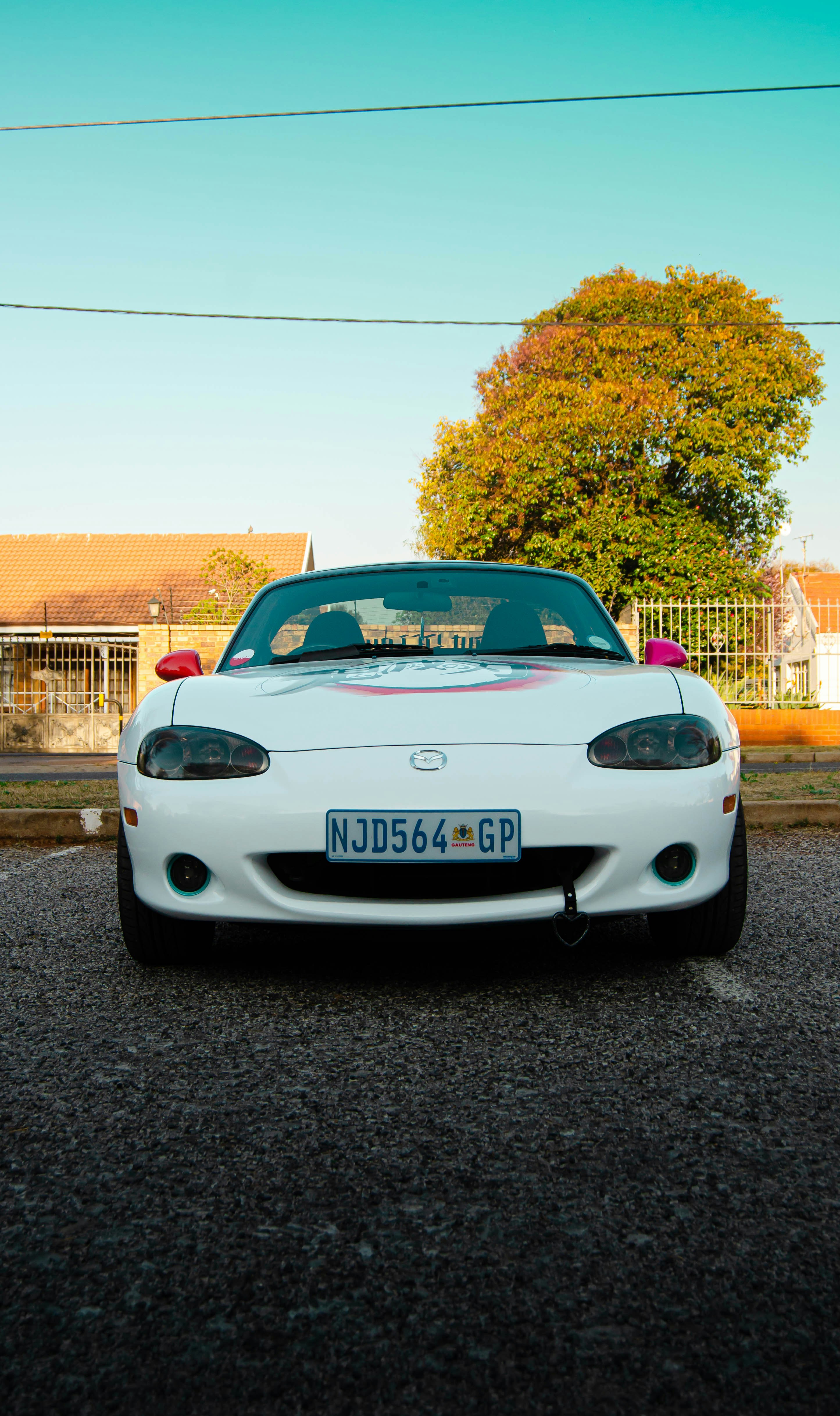 A white car parked on a driveway photo – Free Anime Image on Unsplash
