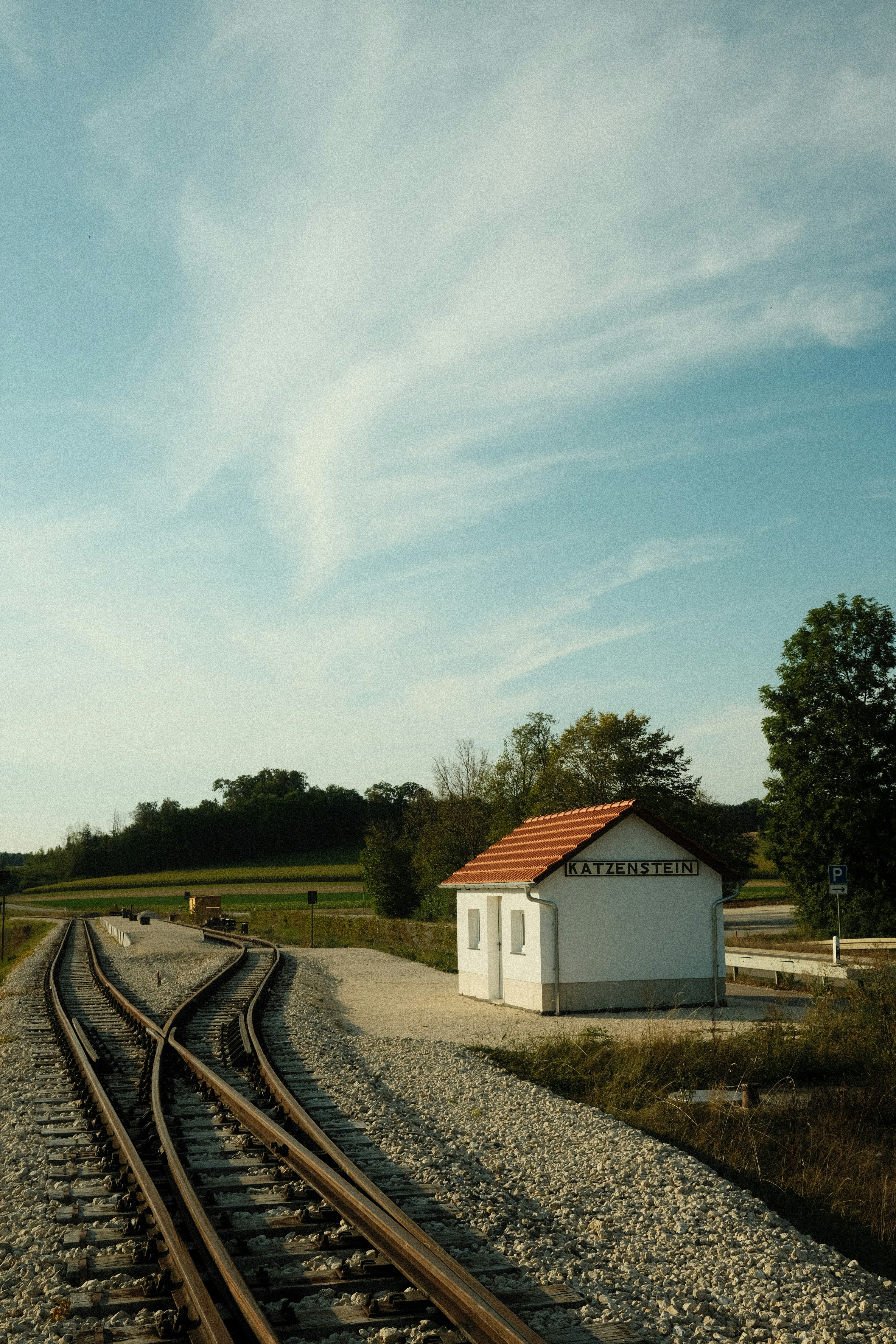 a small building next to train tracks