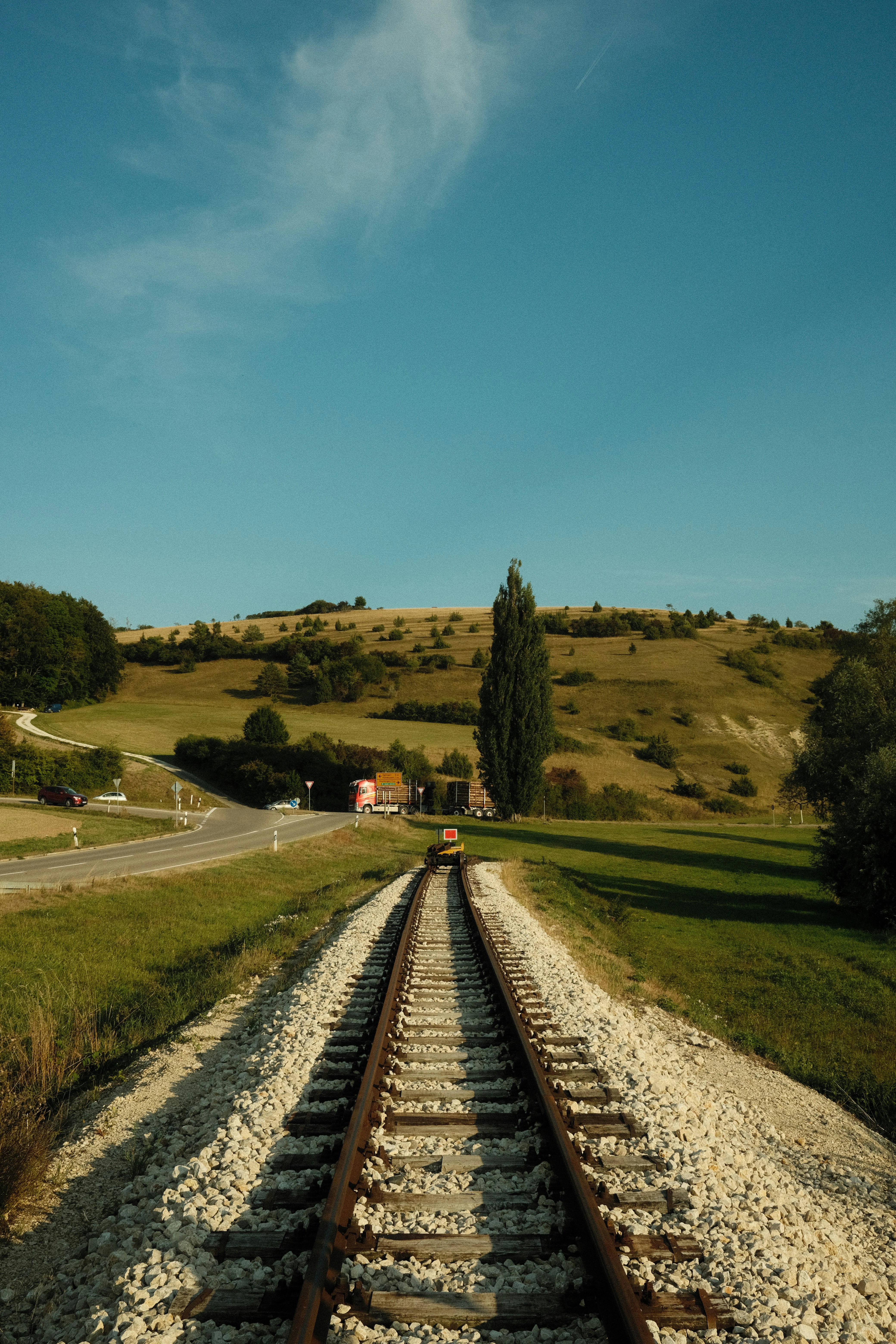 Rails to the Quiet Horizon: A Sunlit Countryside Convergence
