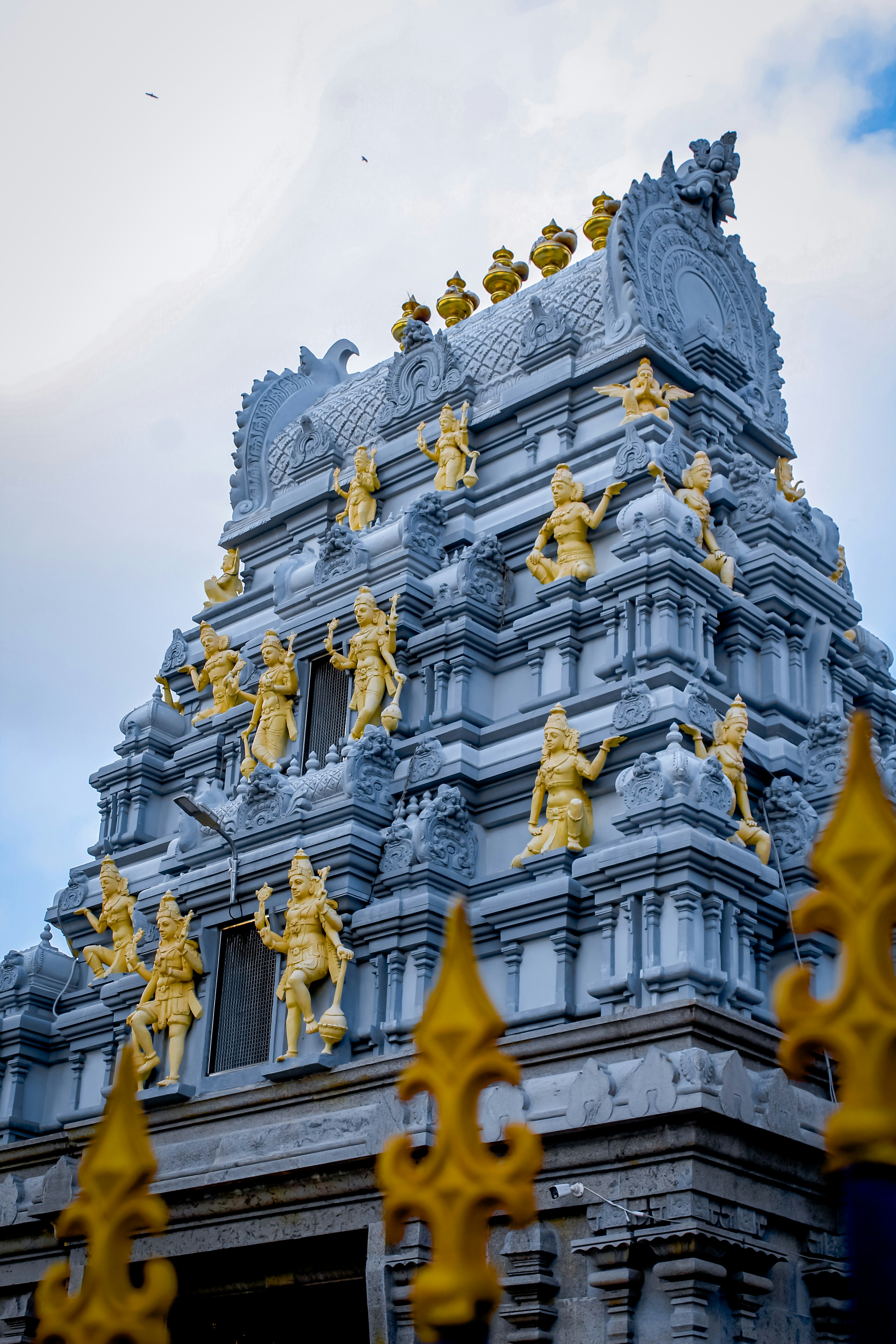 Venkateswar tample in Bhubaneswar  | a building with gold statues