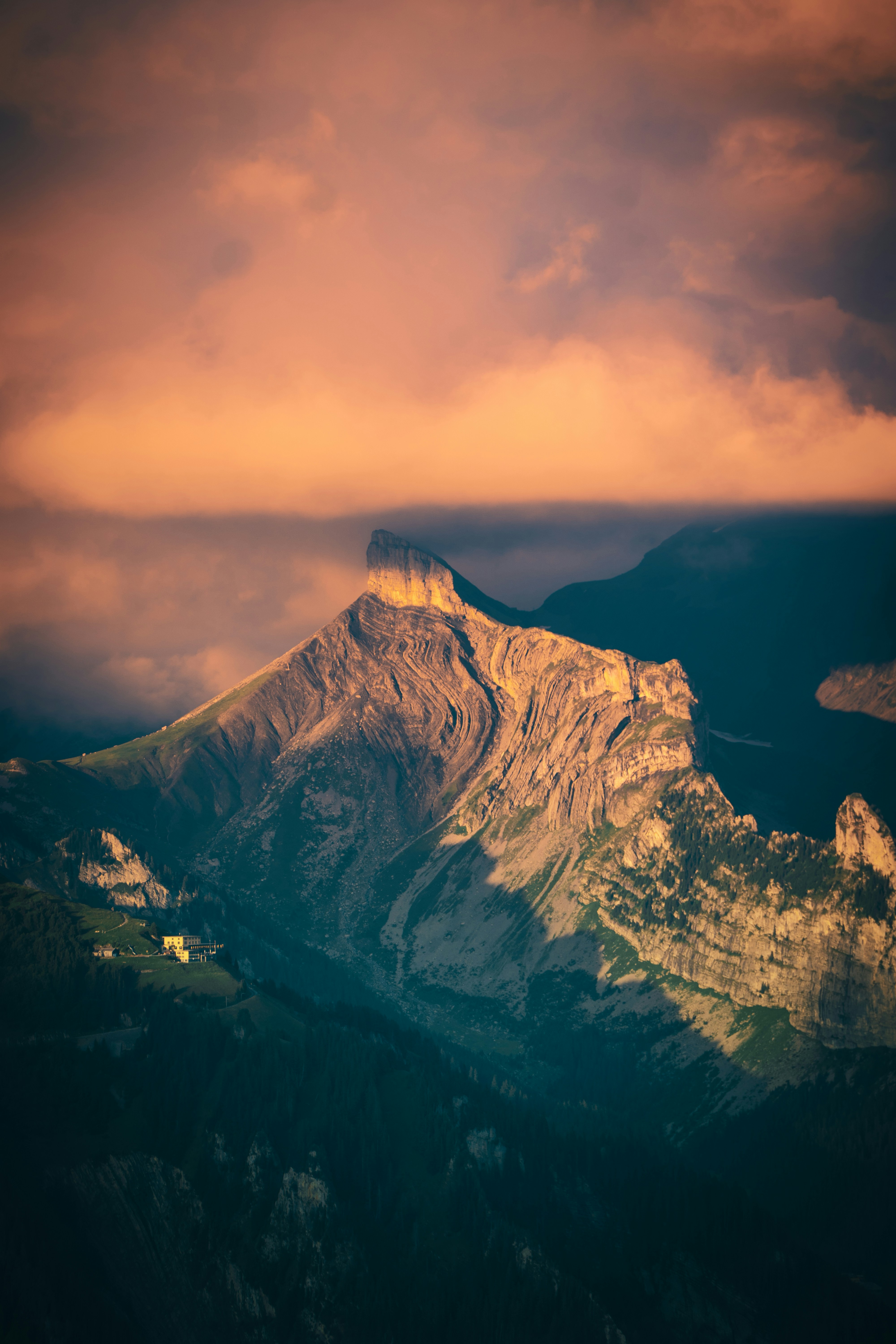 Bathed in Twilight: A Mountain Crest Rises Through Ember Clouds
