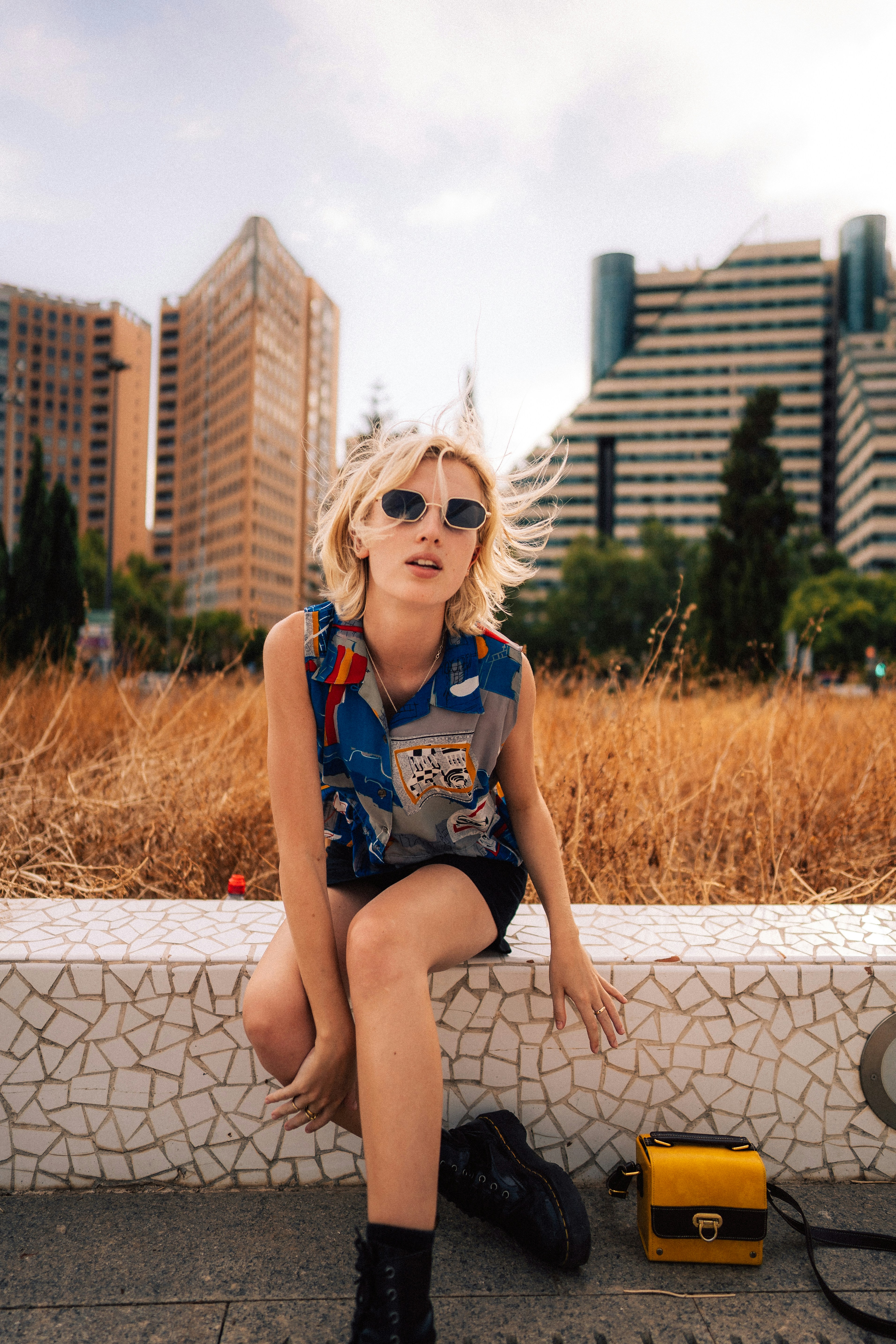 Urban Muse in Sunglasses on a Mosaic Bench