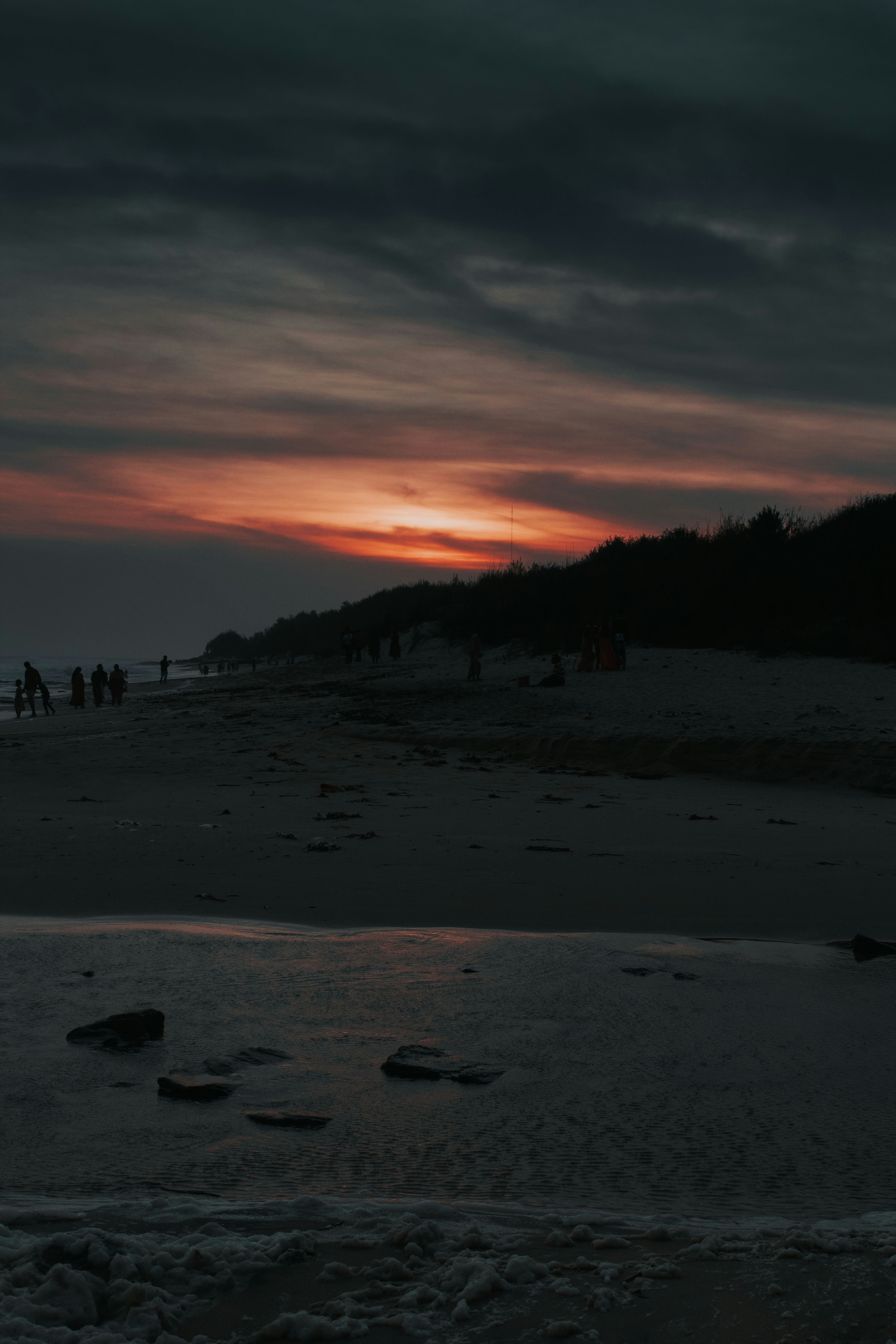 Ember Horizon: Silhouettes Gather at Dusk on a Quiet Seashore