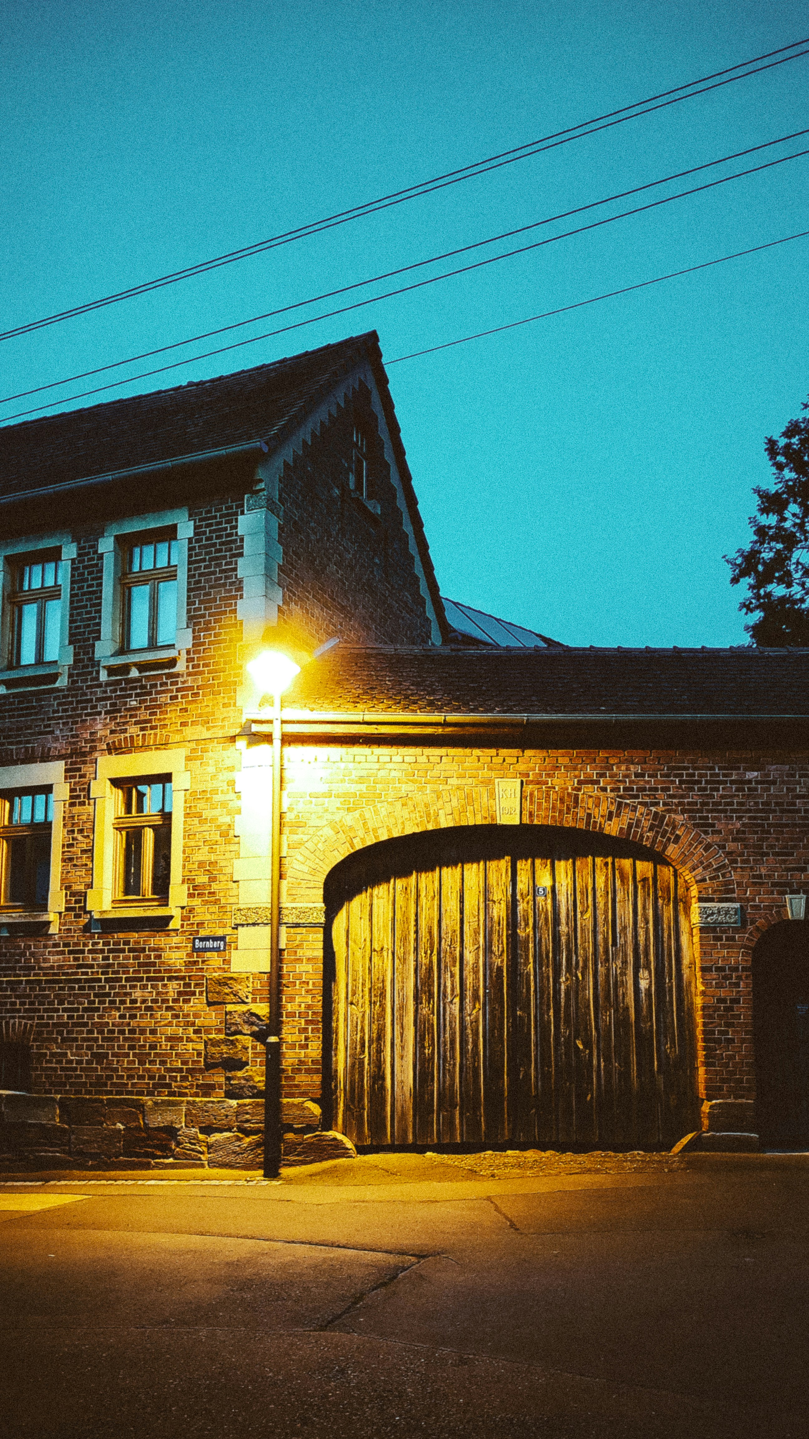 a brick building with a light post
