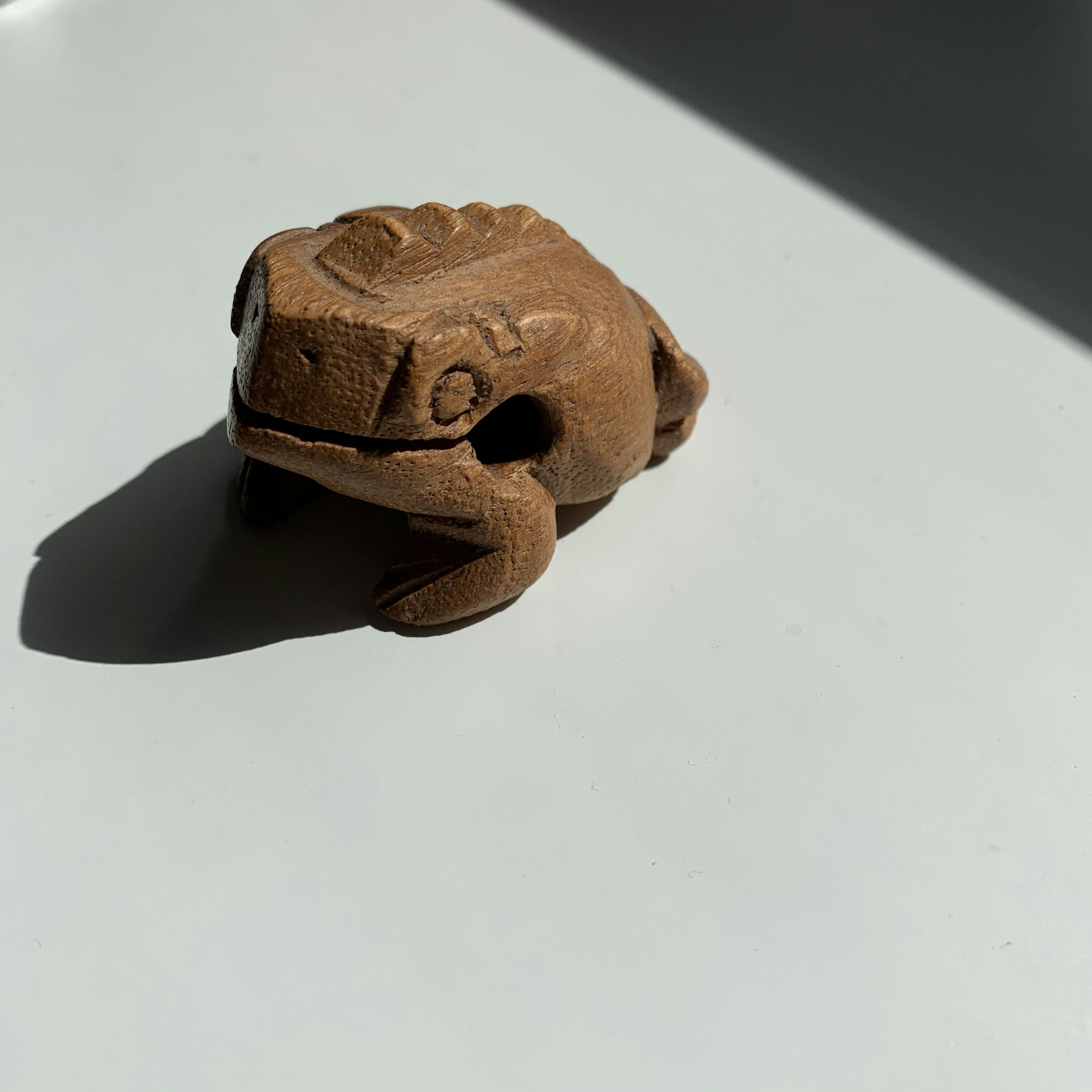 Sunlit Clay Dino in a Quiet Spotlight