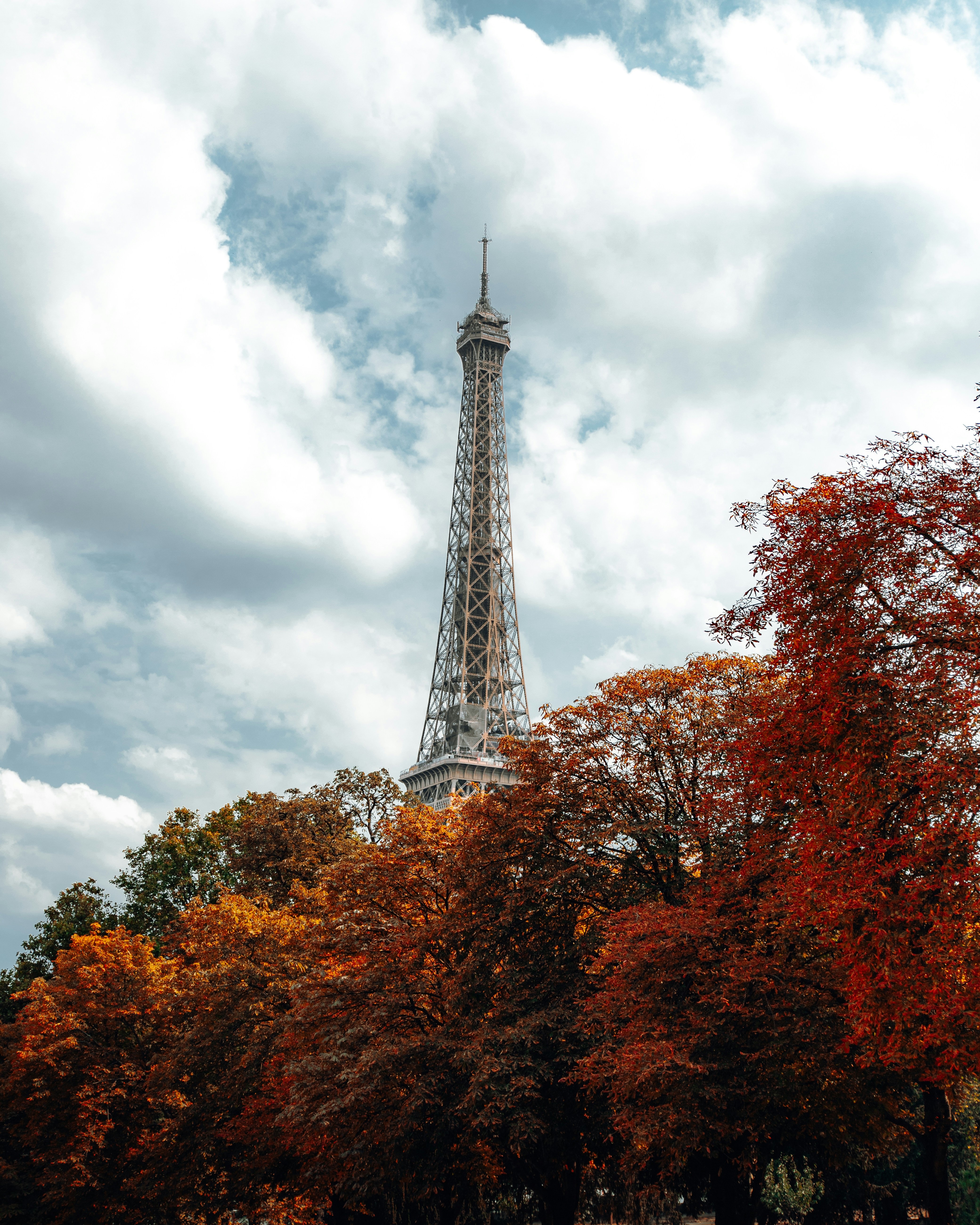 A tall pointy tower with trees around it photo – Free Paris Image on ...