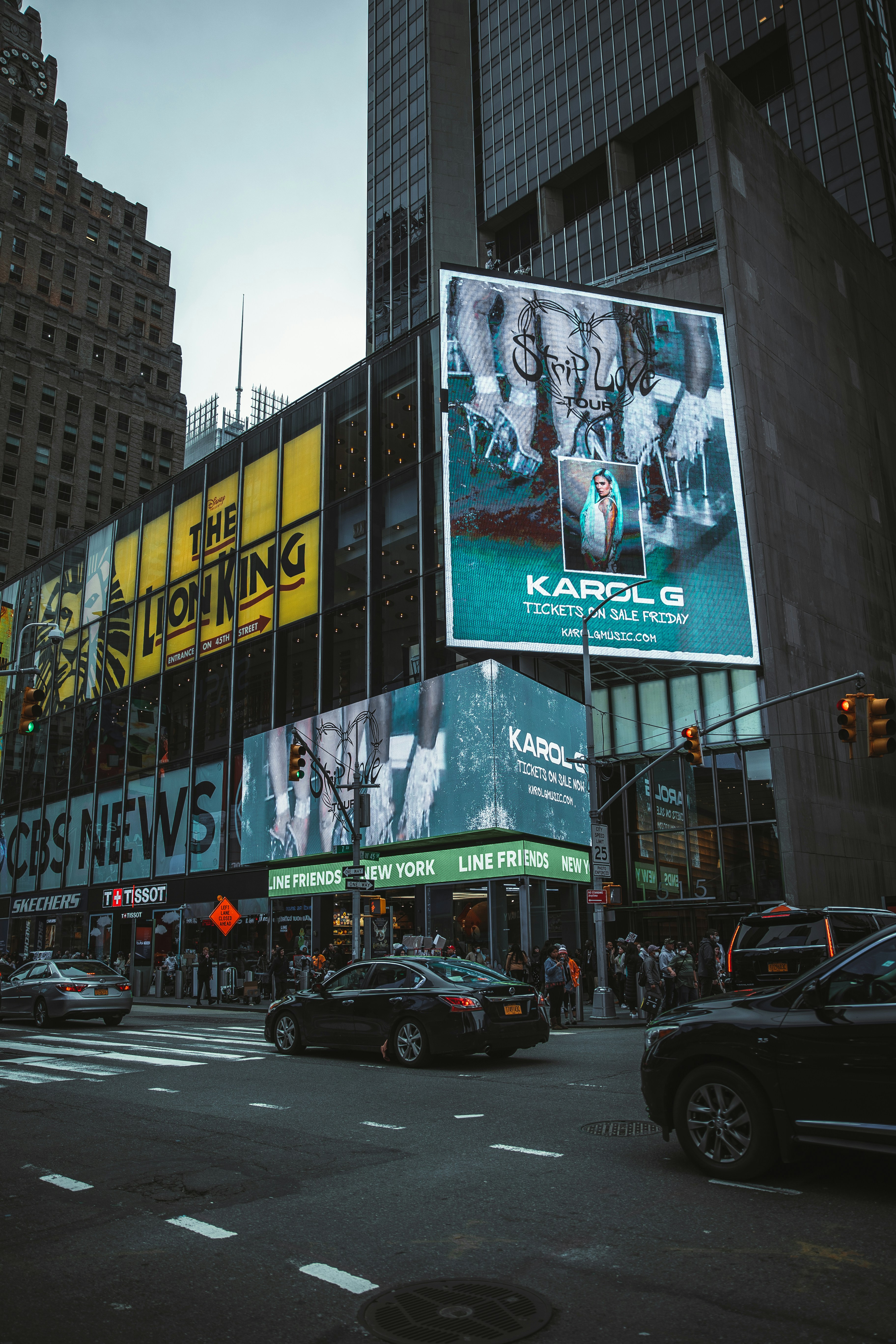 Neon Collision: Karol G Billboard Illuminates a Busy NYC Street