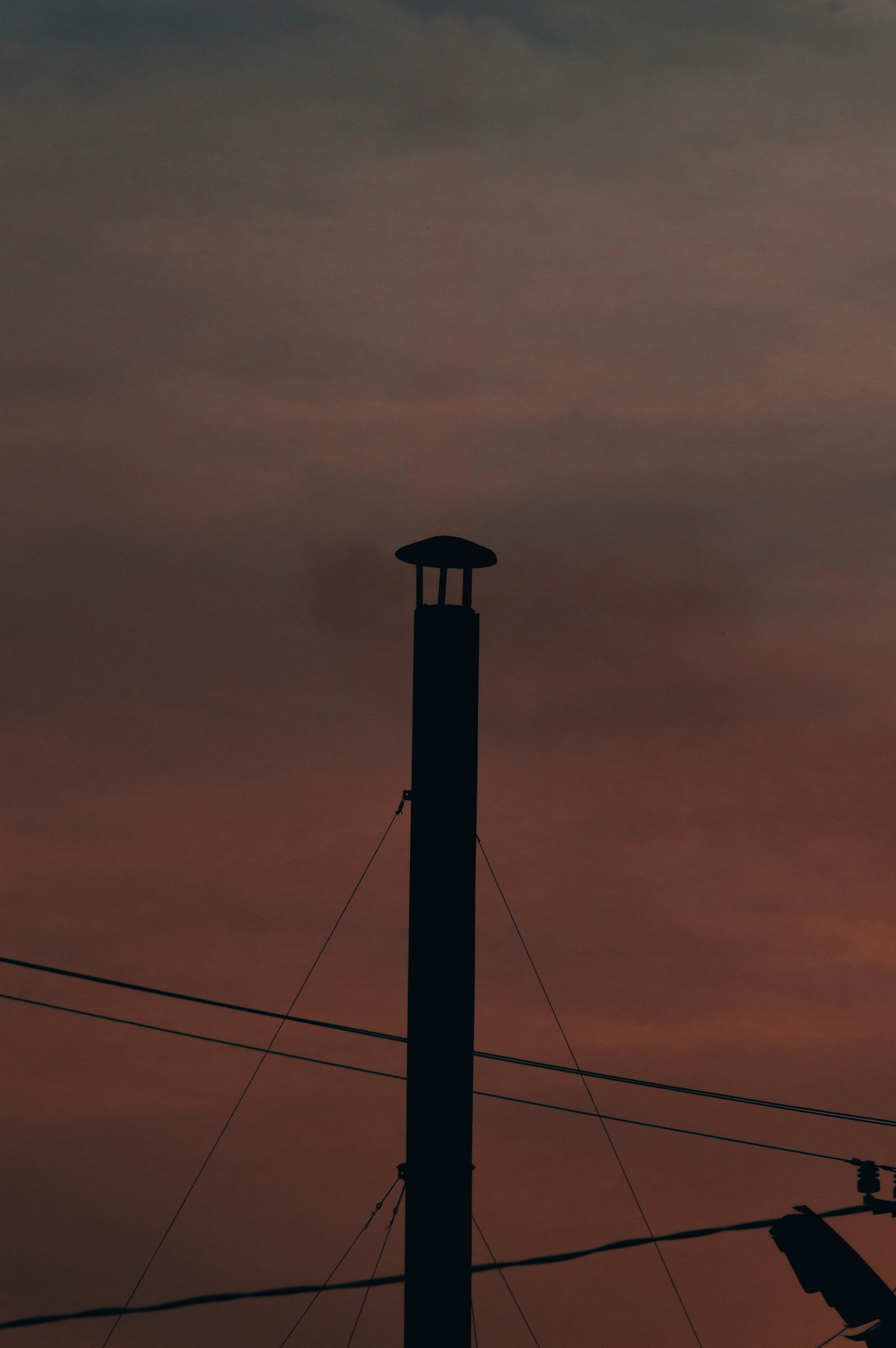 Silhouetted Chimney Reaching Toward a Tempest Sky