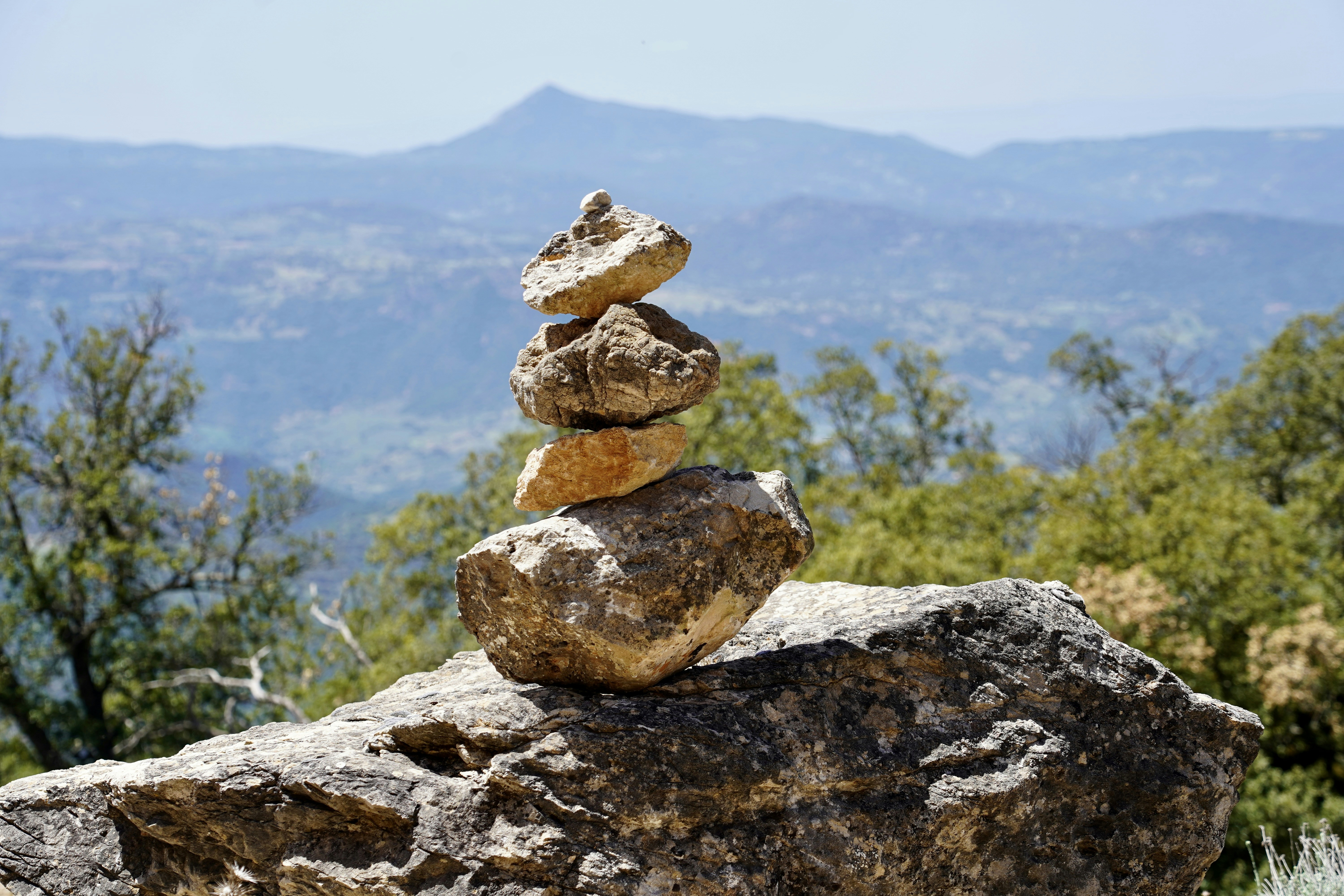 A stack of rocks on a mountain photo – Free Oliena Image on Unsplash