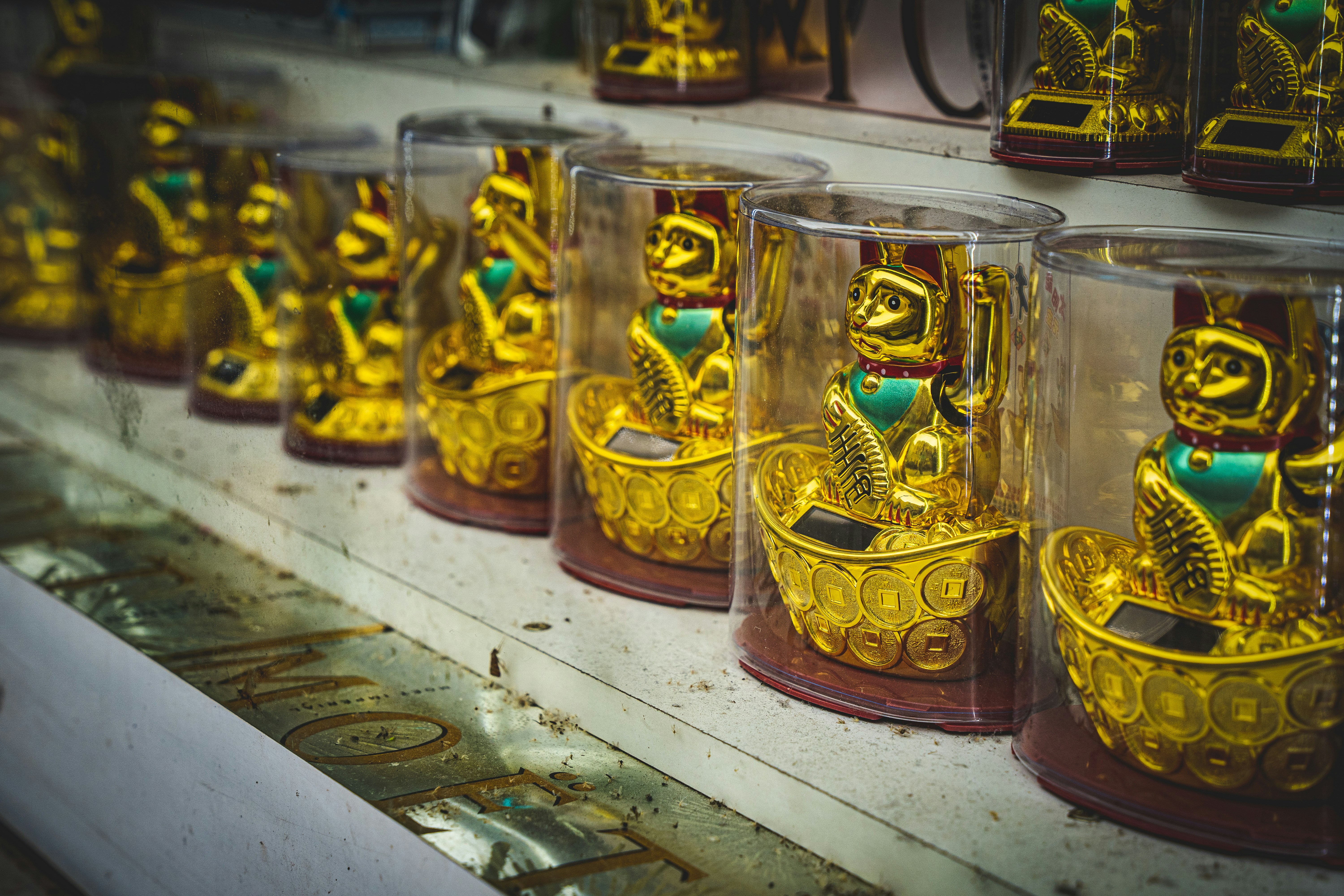 Golden Guardians: A Row of Fortune Cats