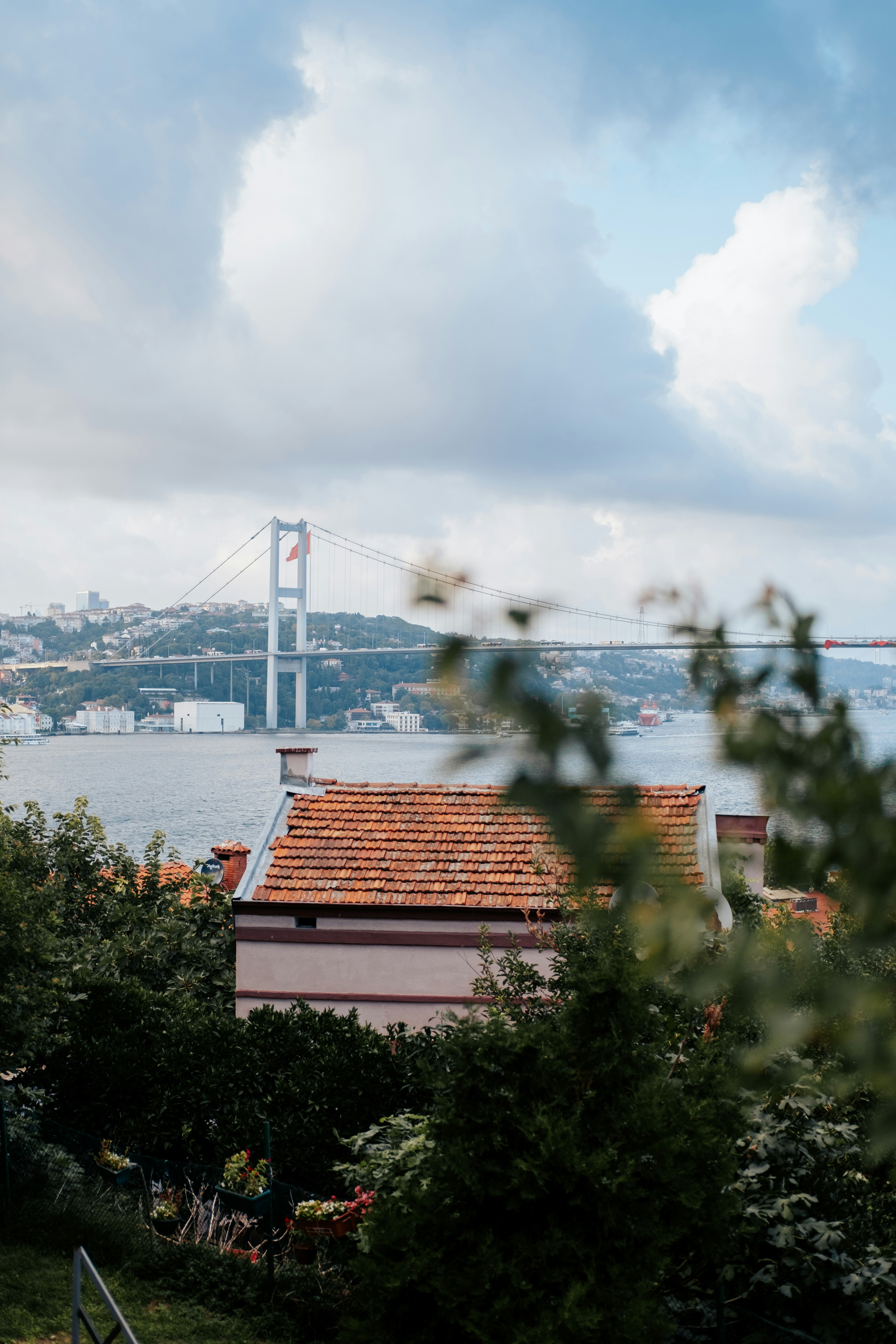 A building with a bridge in the background photo – Free Roof Image on ...