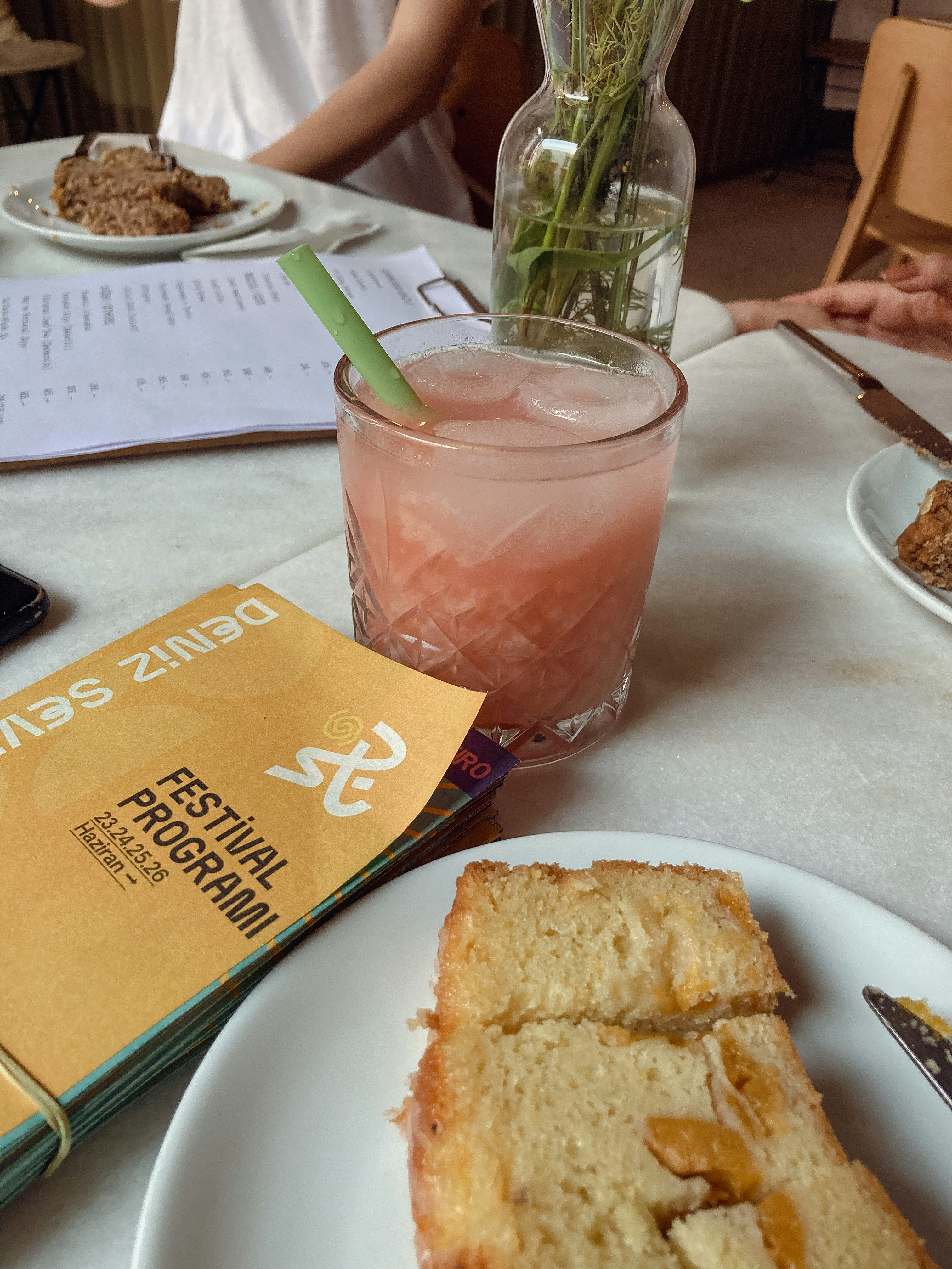 a glass of juice next to a plate of food
