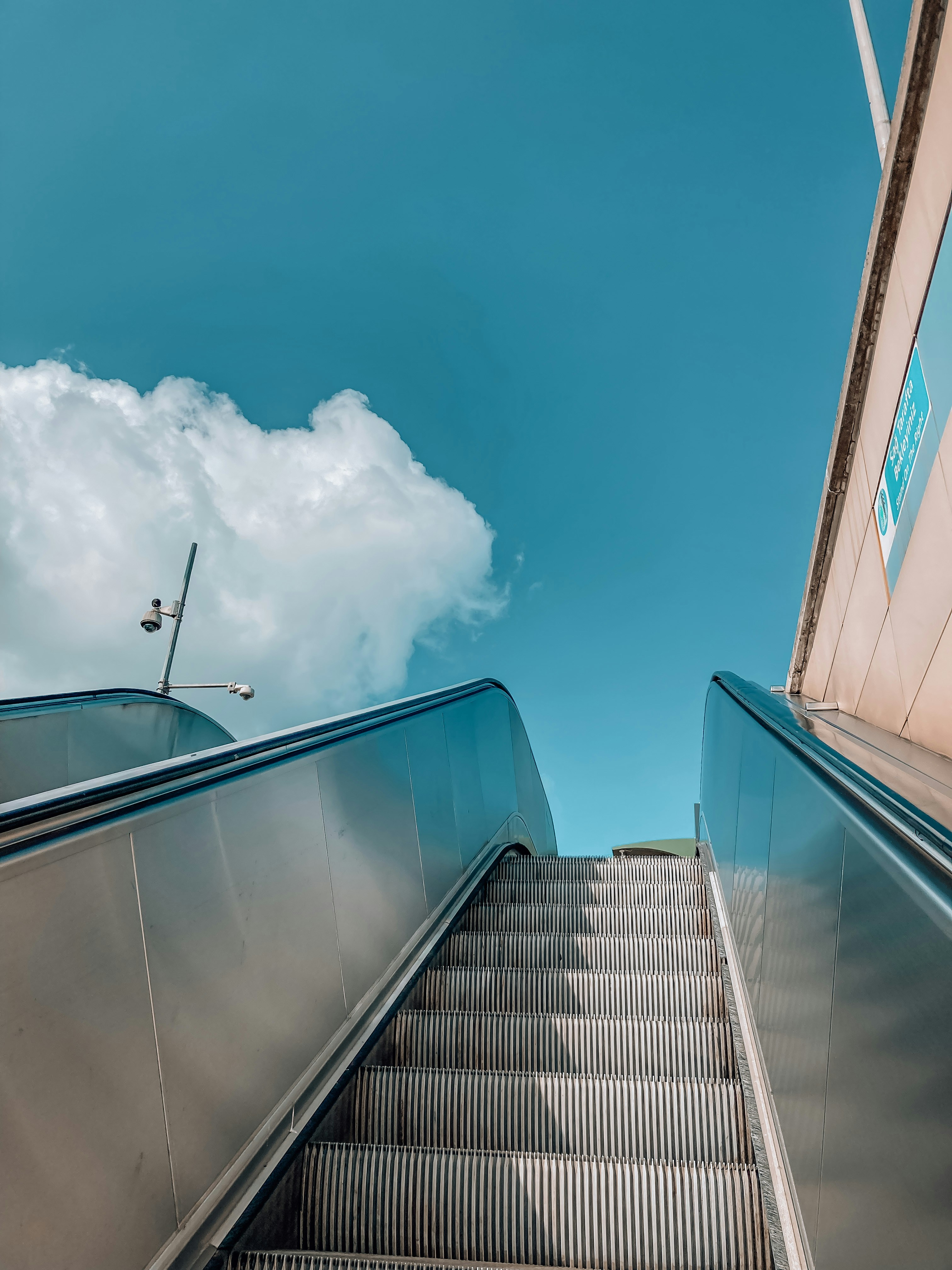 Azure Ascent: Escalator toward a Sky-Swept Horizon