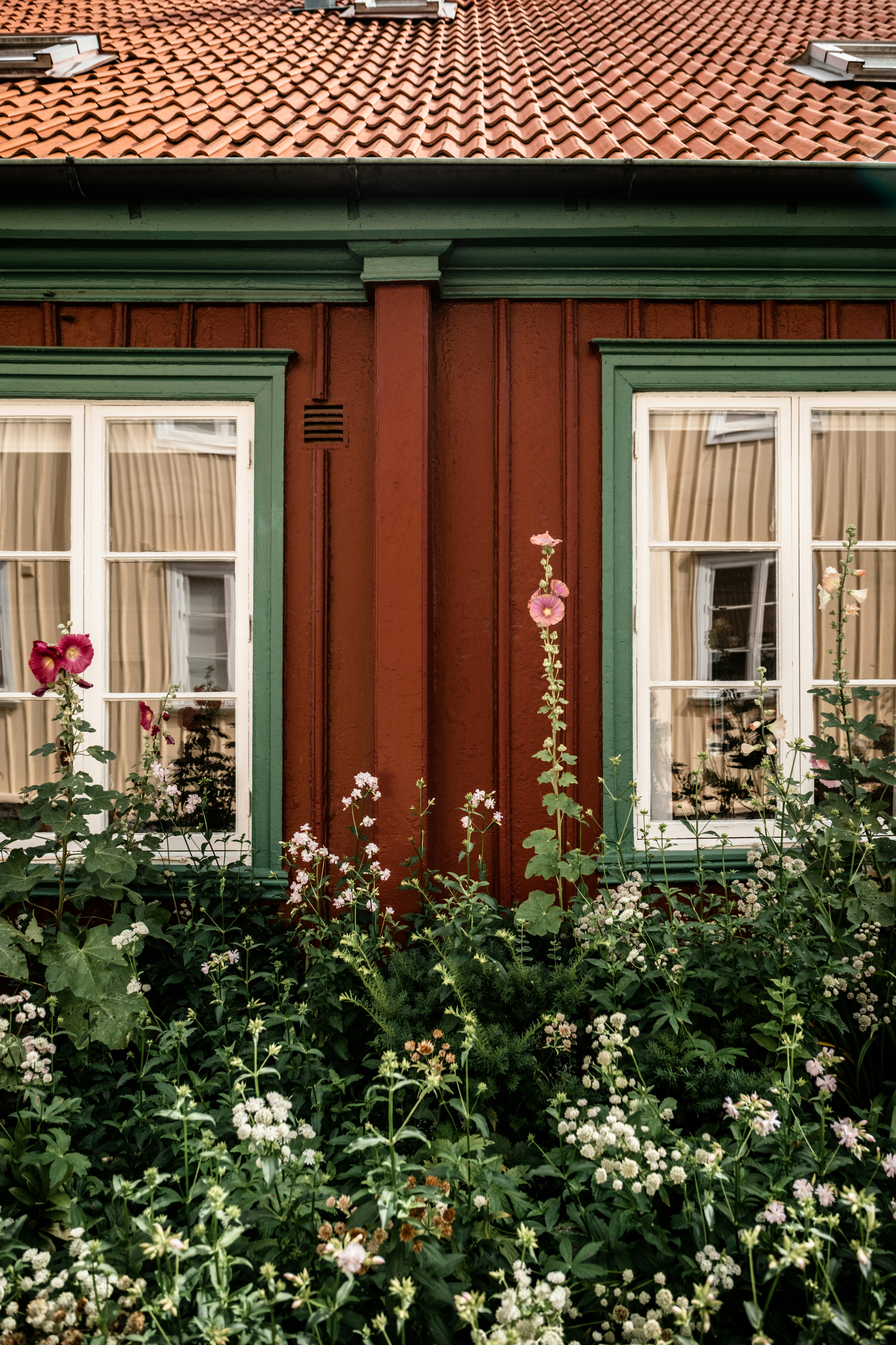 Crimson Facade, Emerald Frames, and a Garden in Bloom