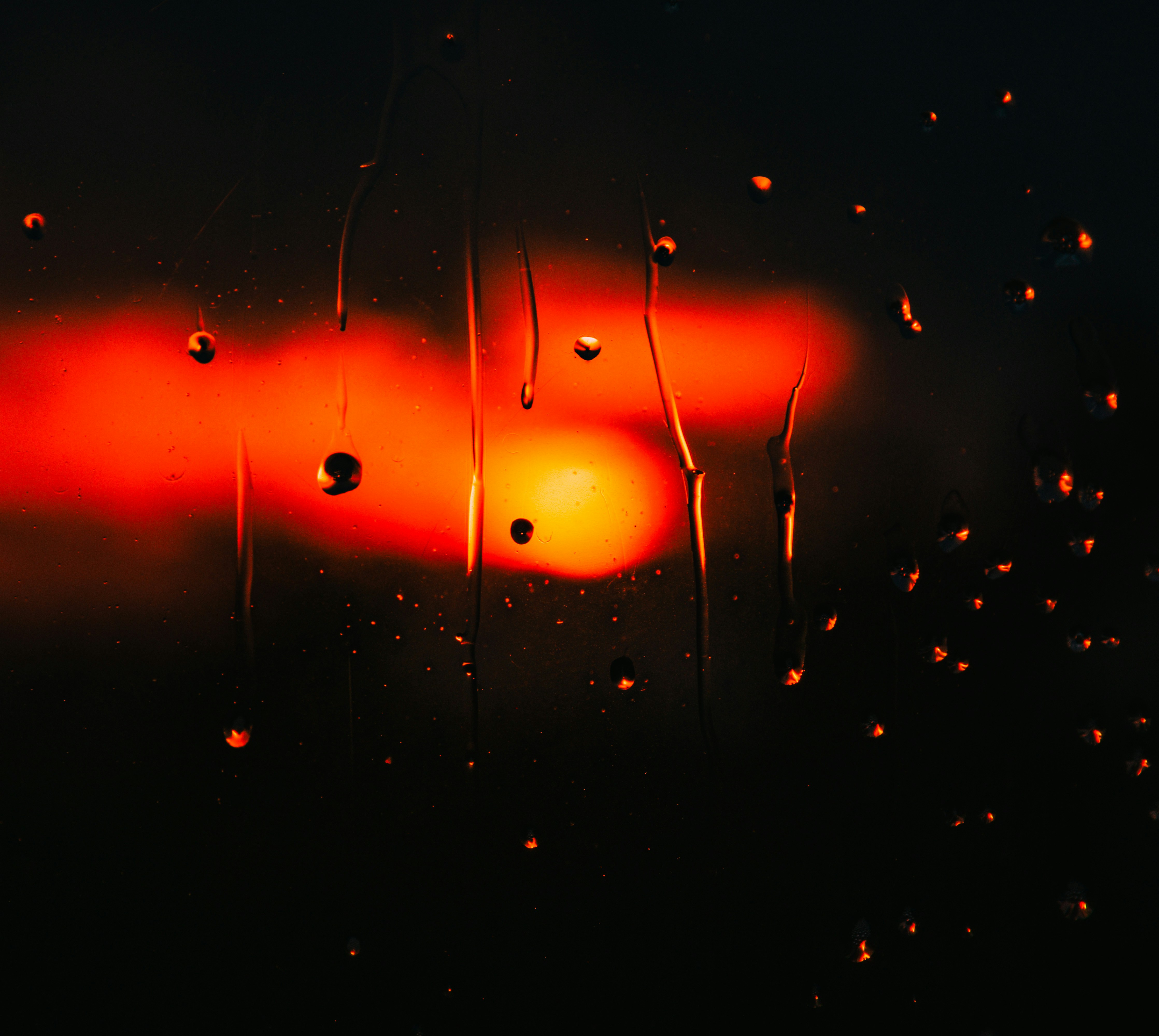 Hazy Neon Through Rain-Streaked Glass at Night