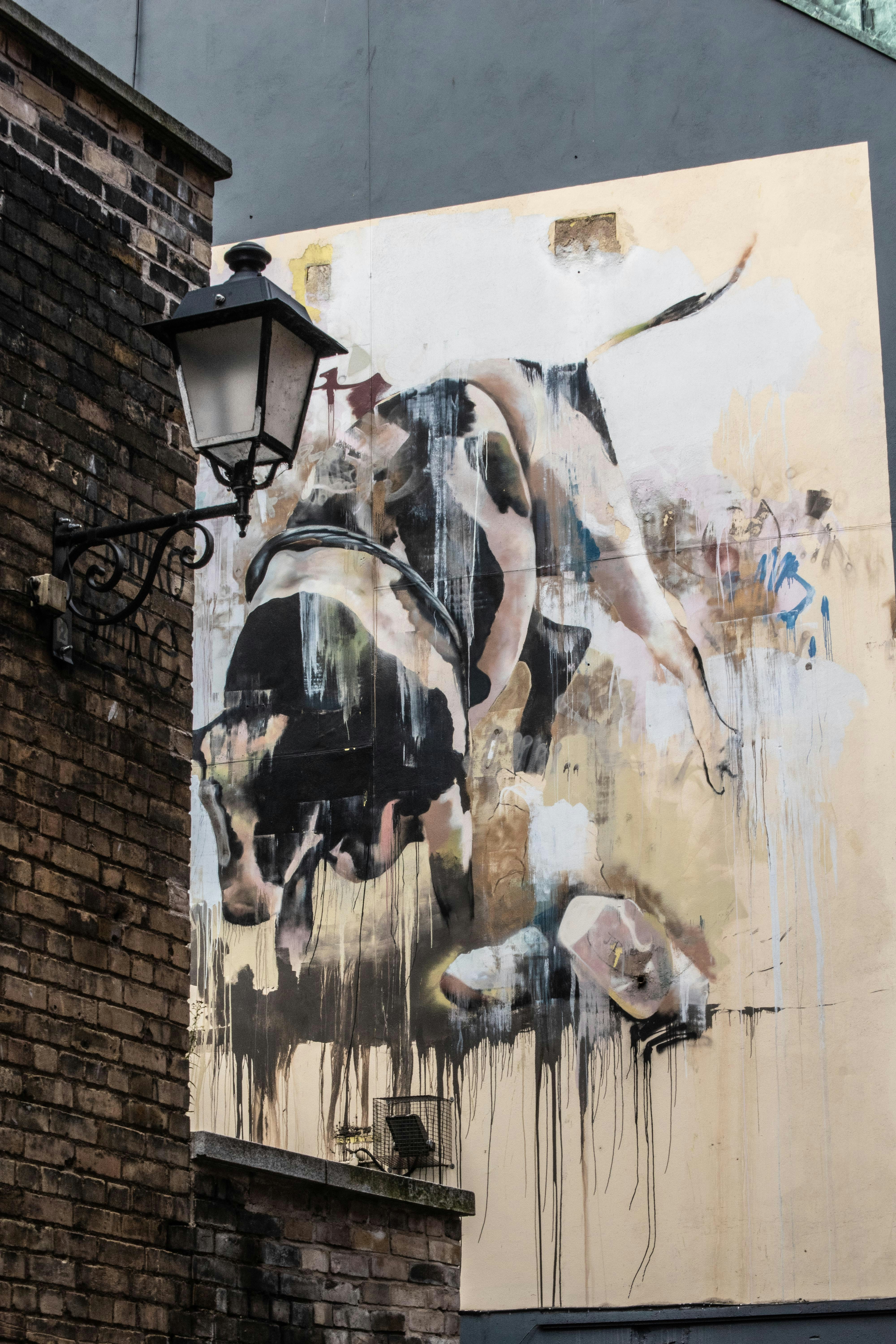 Graffiti Mural on Brick Wall with Vintage Street Lamp