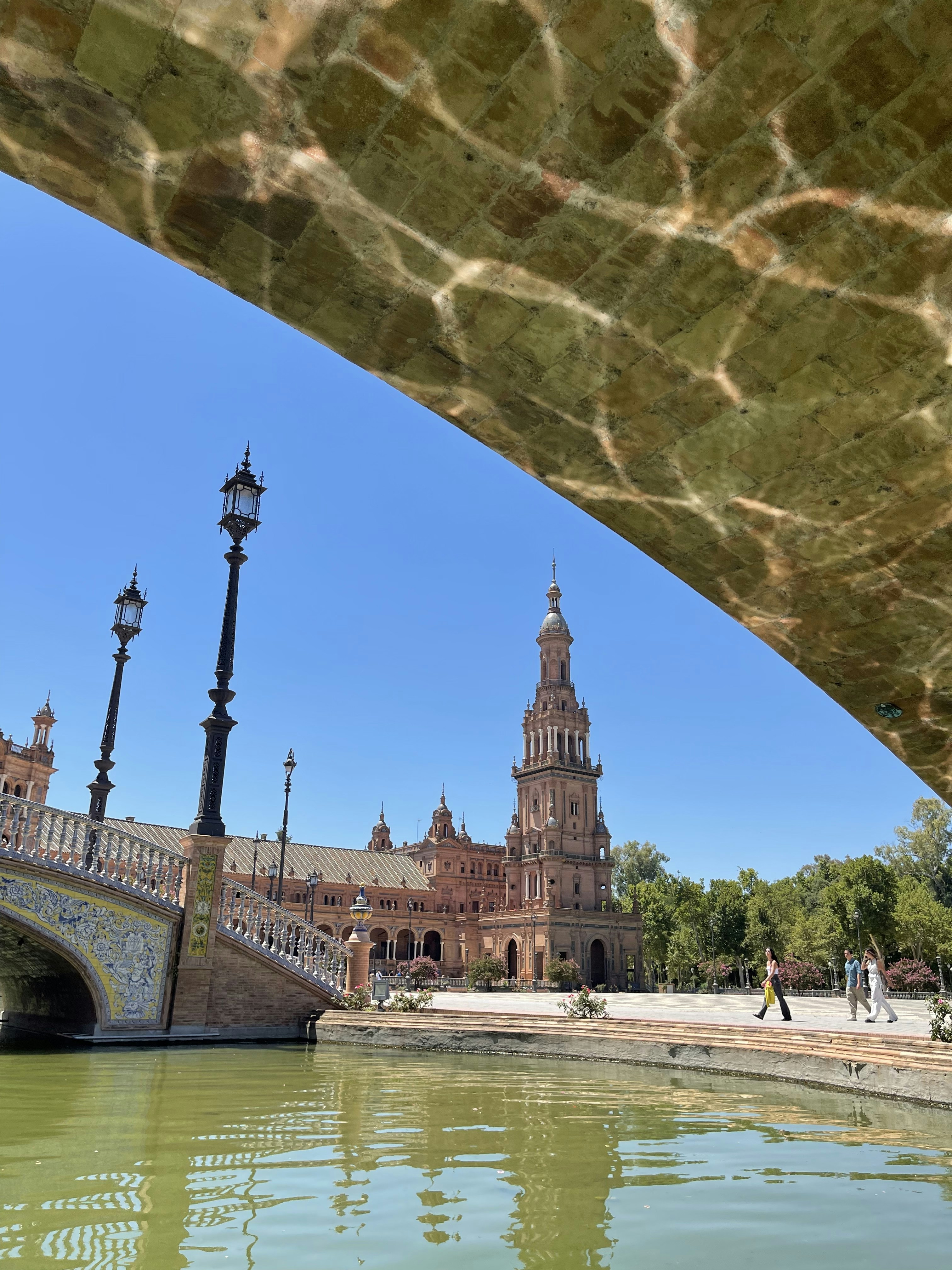 rowing through the canal in sevilla plaza de españa 