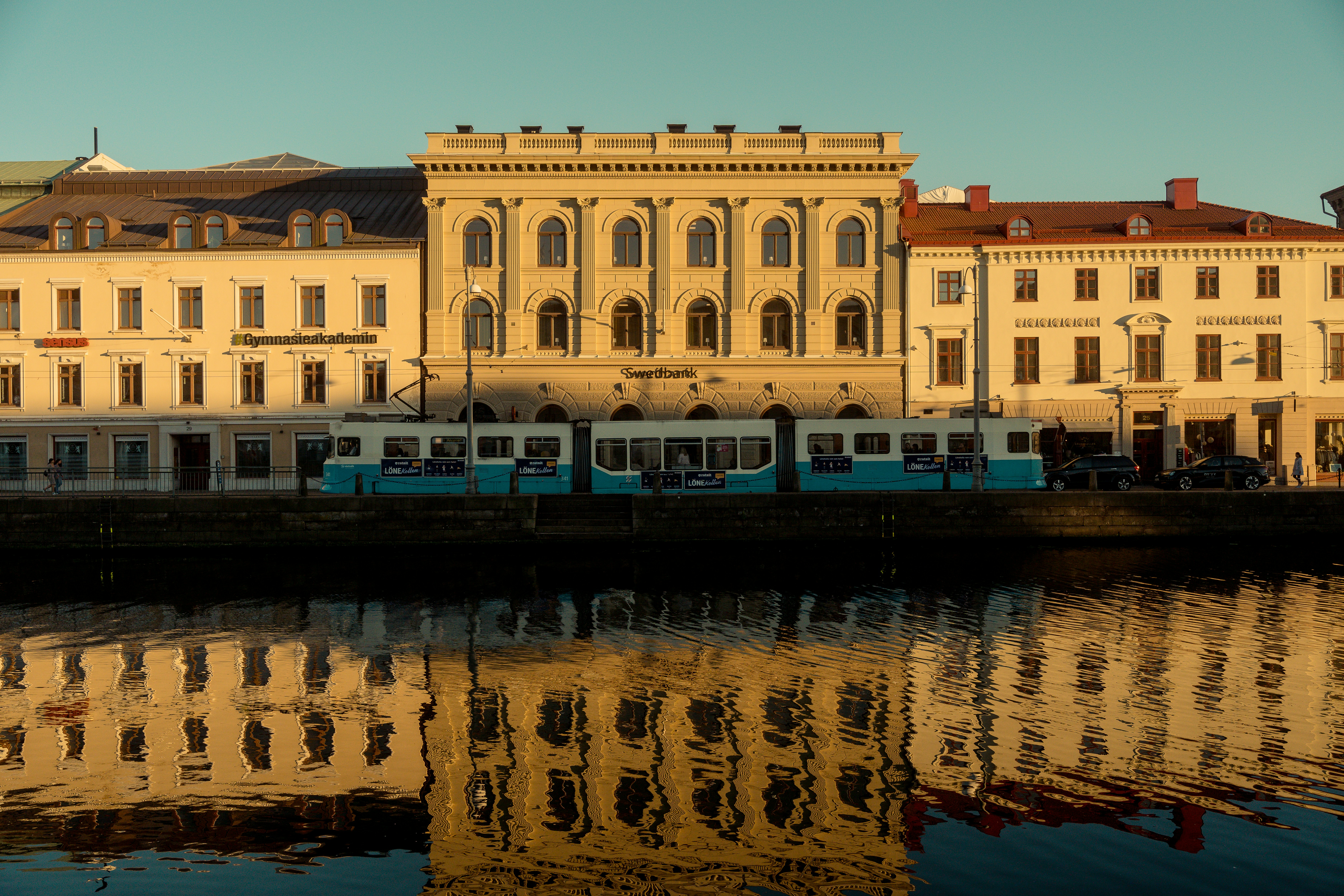 a boat in a canal in front of a large building with Schönbrunn Palace in the background