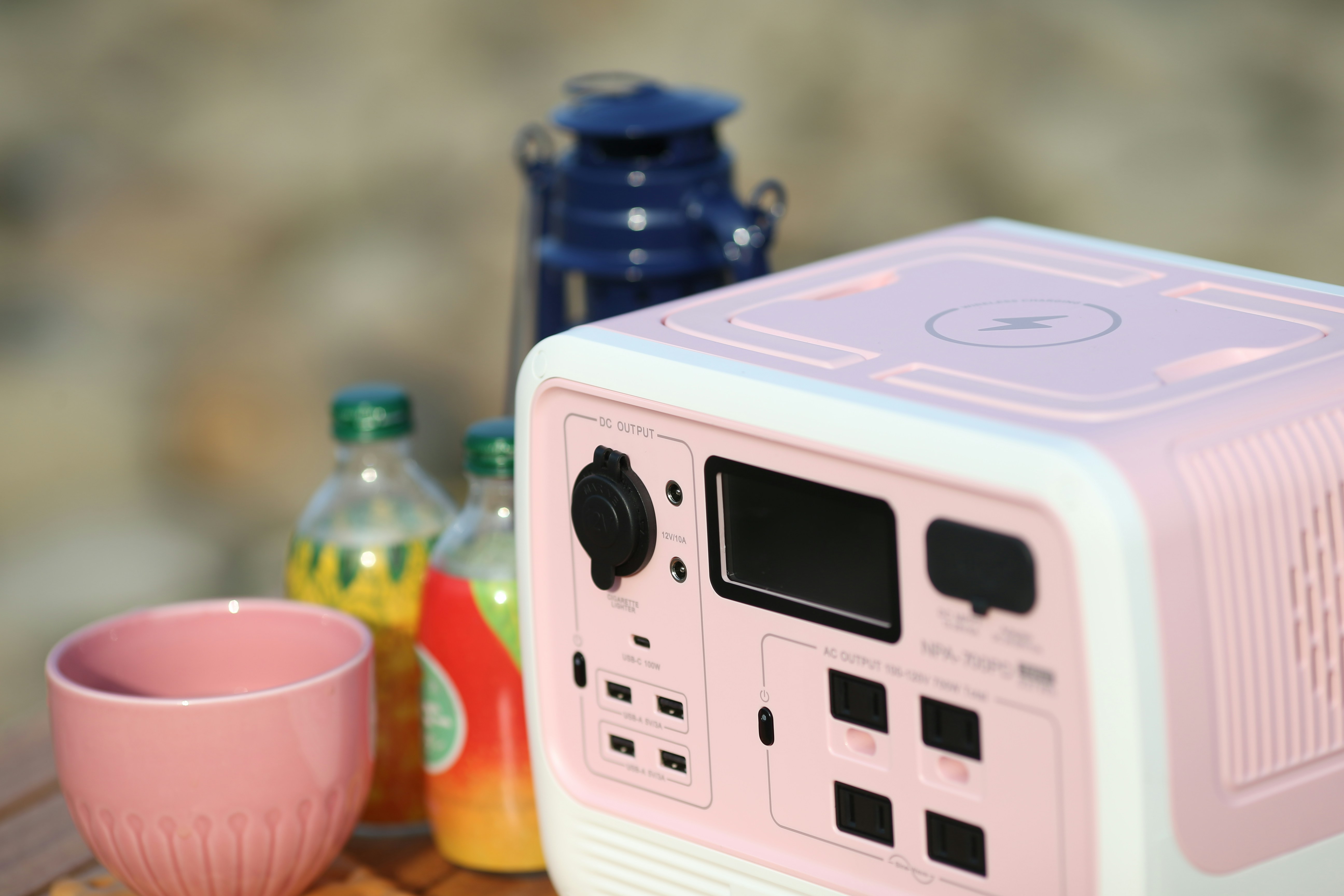 a white and pink electronic device with bottles of liquid on the side