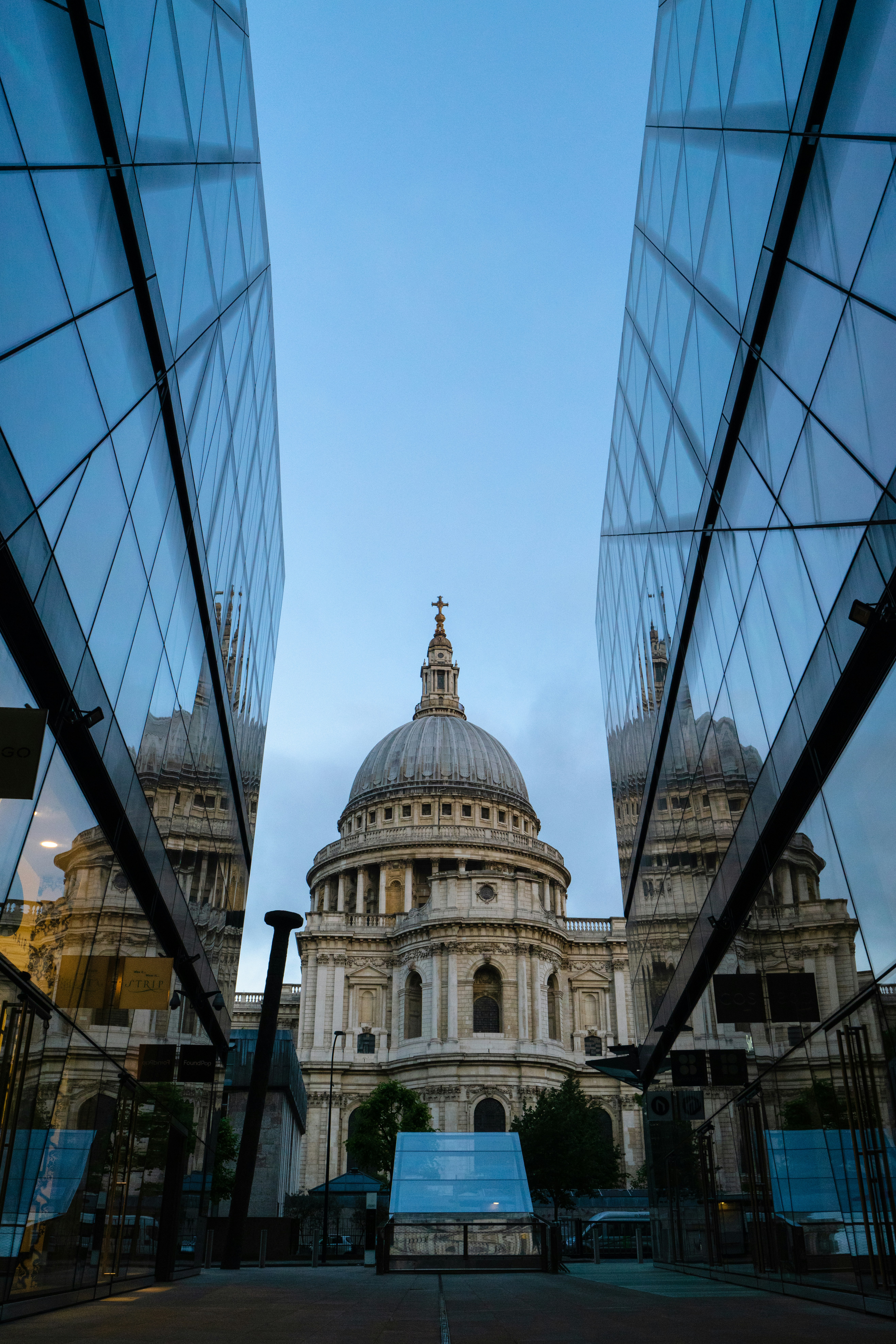 St. Paul's Cathedral framed by glass structures, showcasing a blend of historic and contemporary design elements.