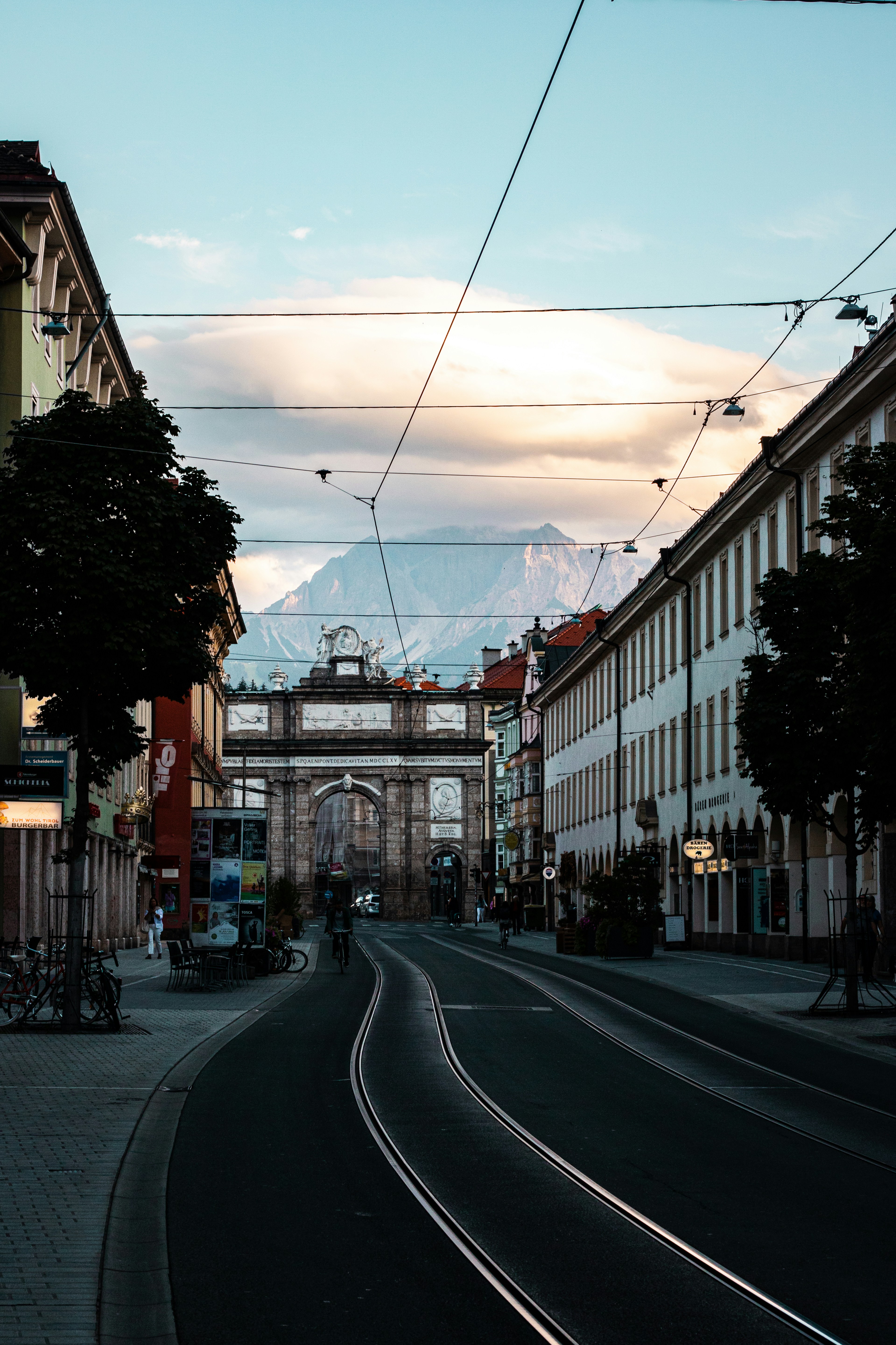 Gateway Arch and Rails: City Street Framing Alpine Peaks