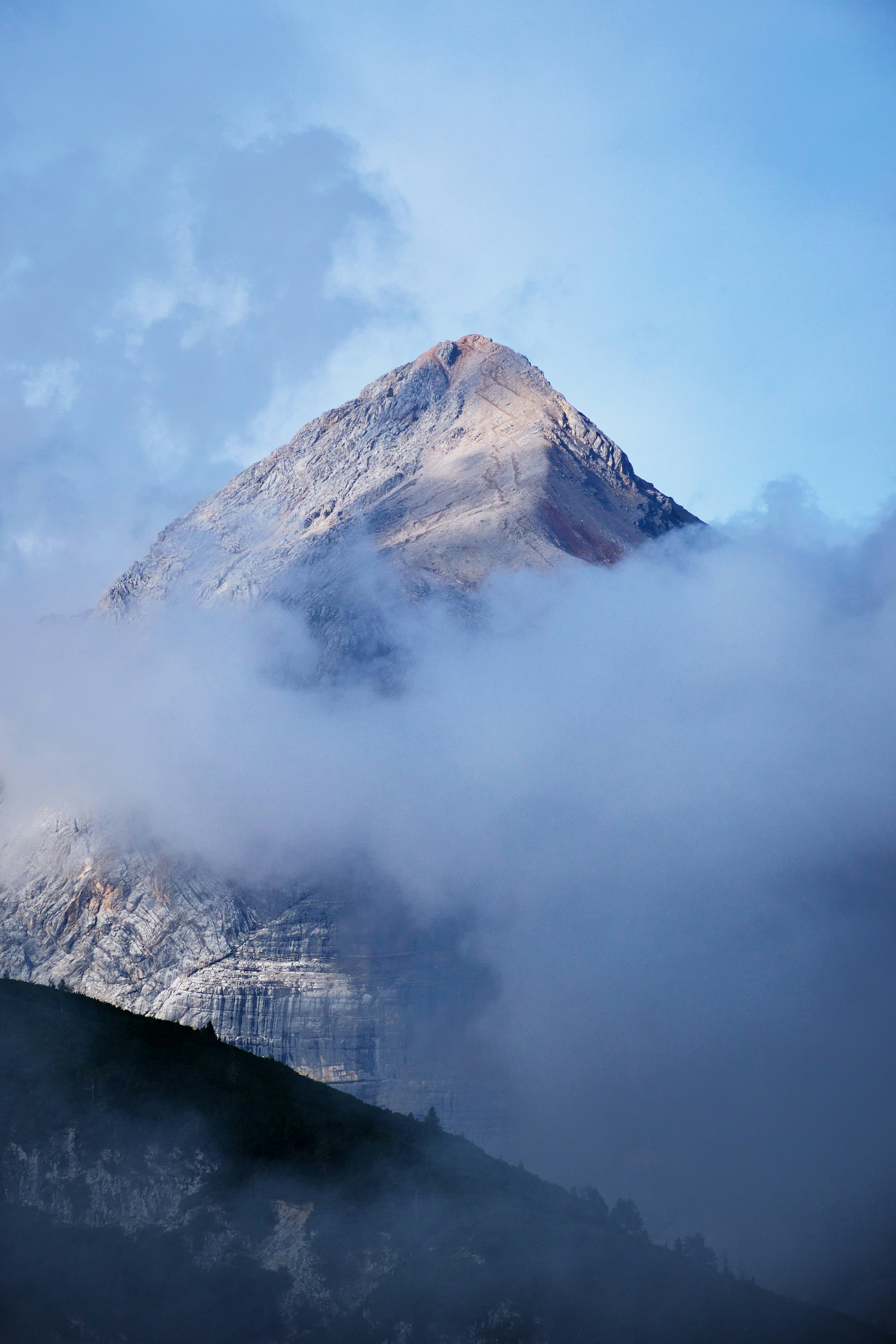 Crowned Peak Emerging Through a Veil of Alpine Mist