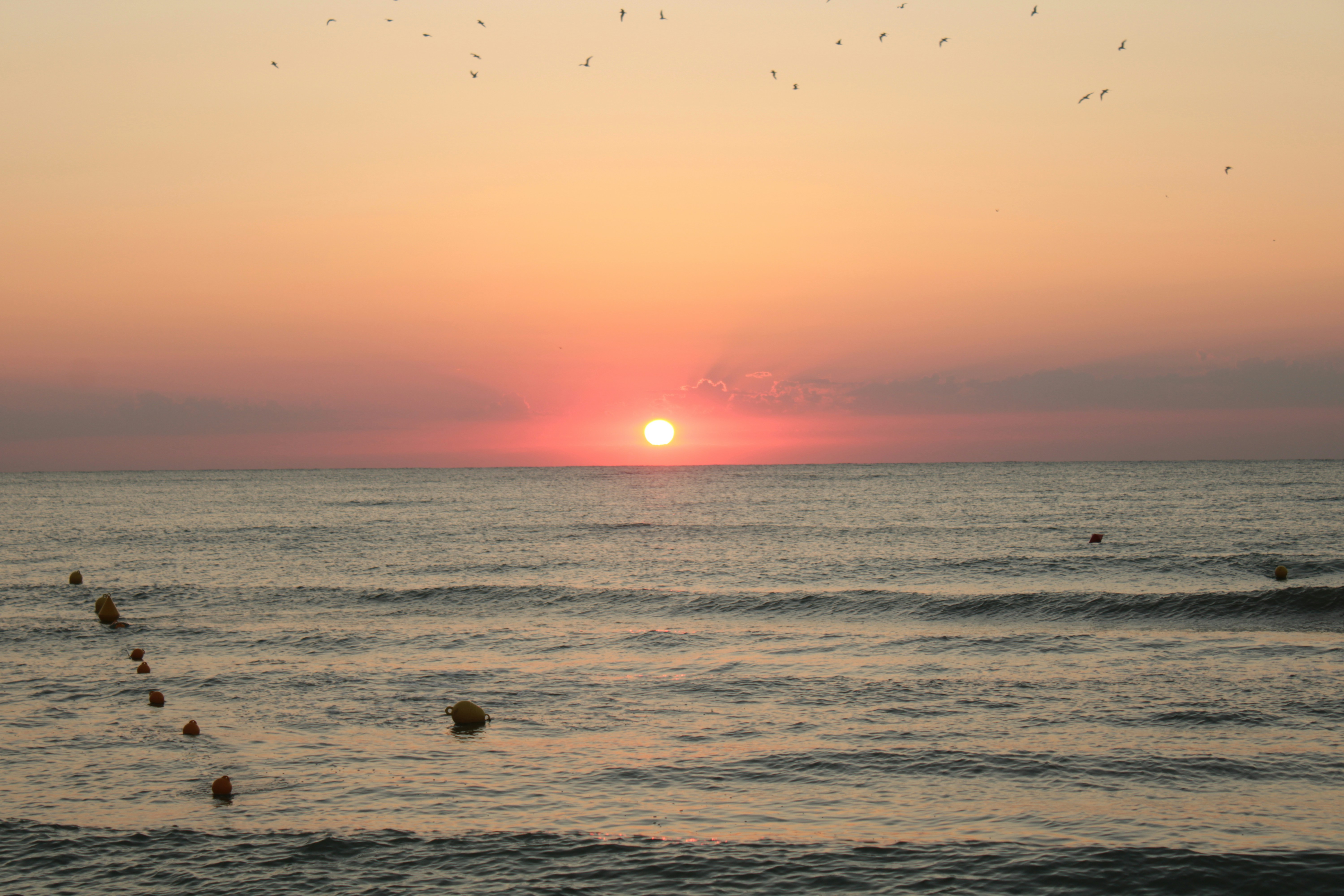 Horizon Quiet: Buoy Line Marks the Dusk Over a Calm Sea