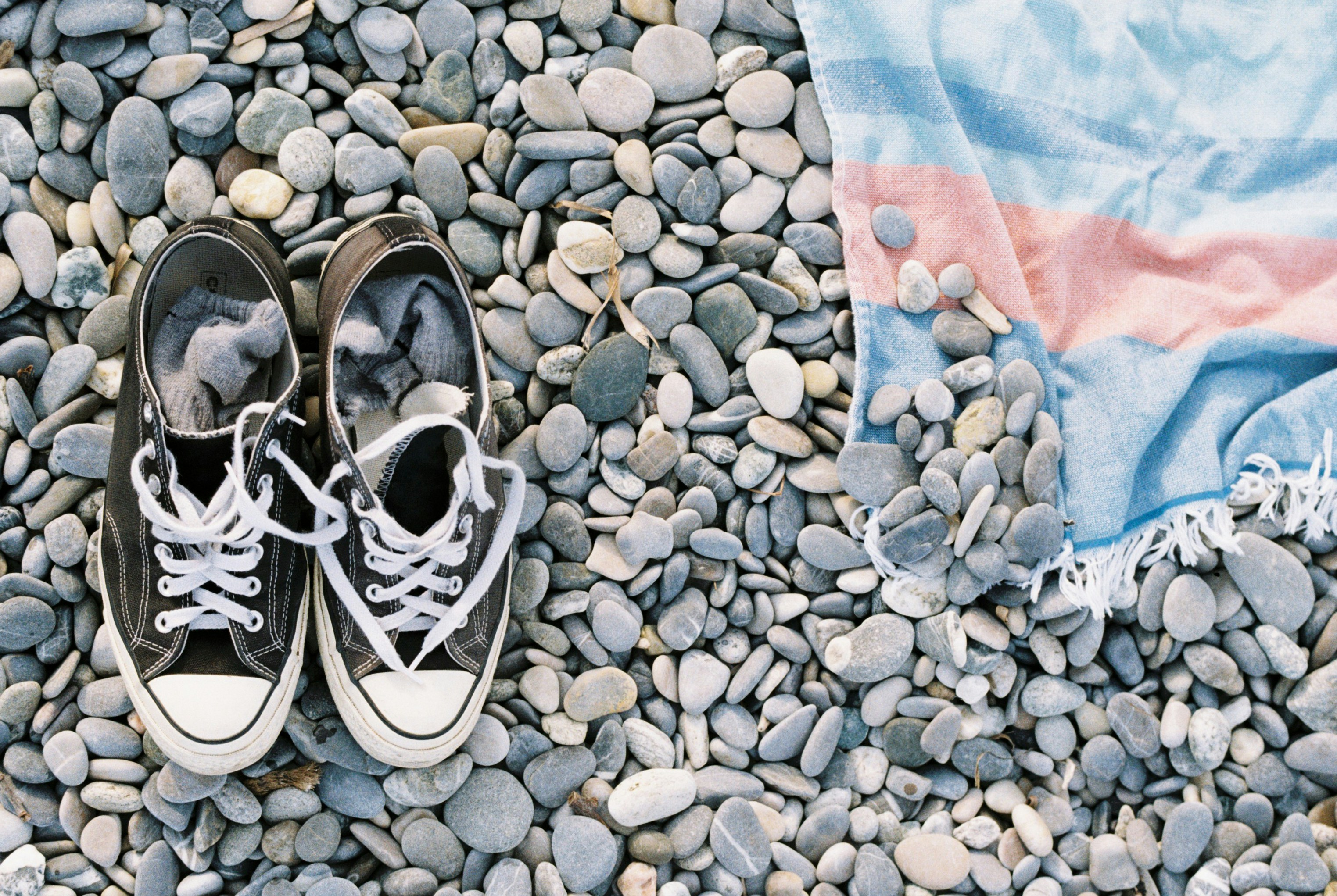 Converse on a Pebble Shore: Quiet Morning by a Striped Towel
