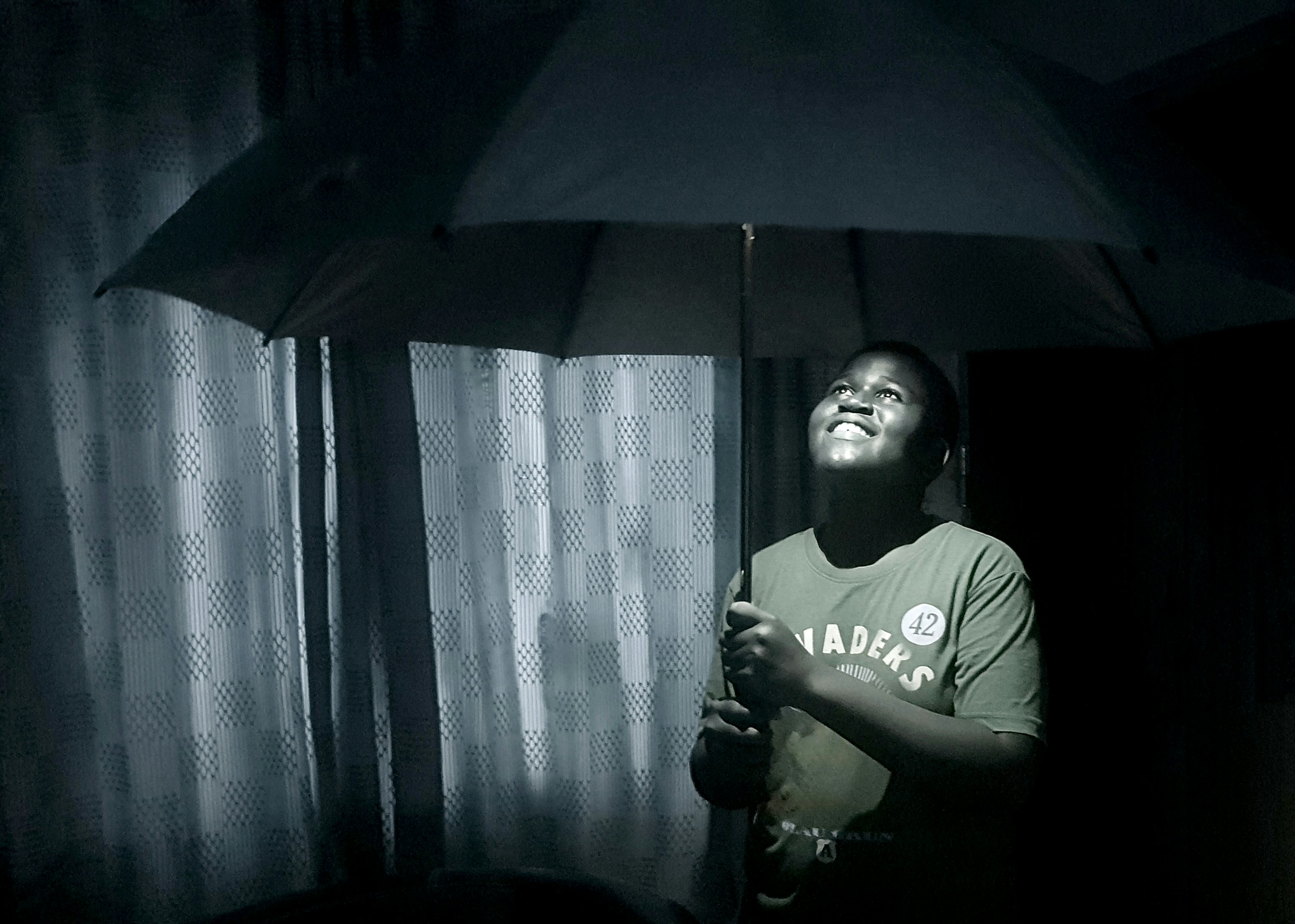 Midnight Umbrella Portrait: A Quiet Figure in Dim Glow