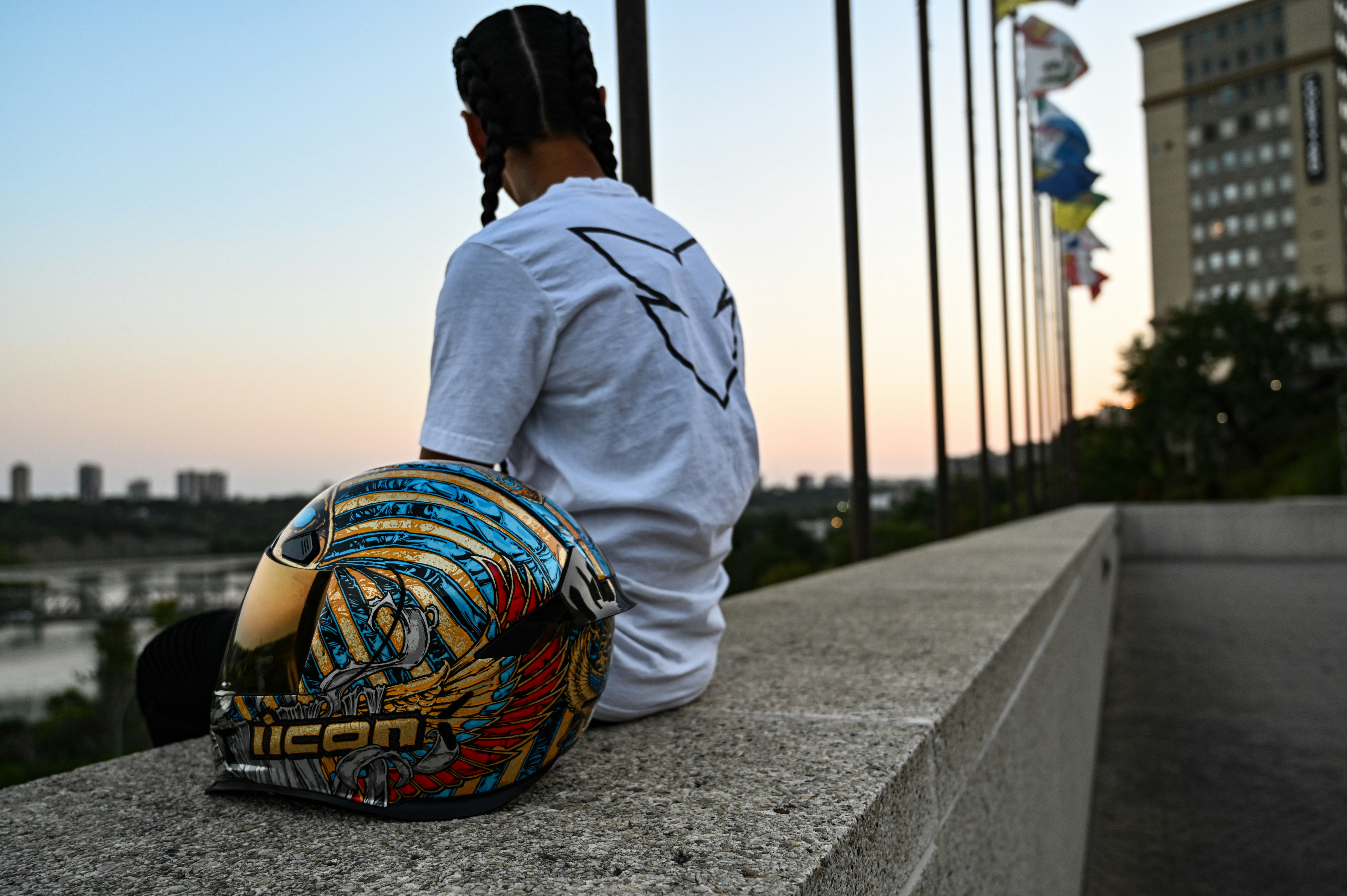 A person sitting on a ledge with a ball in front of them photo – Free ...
